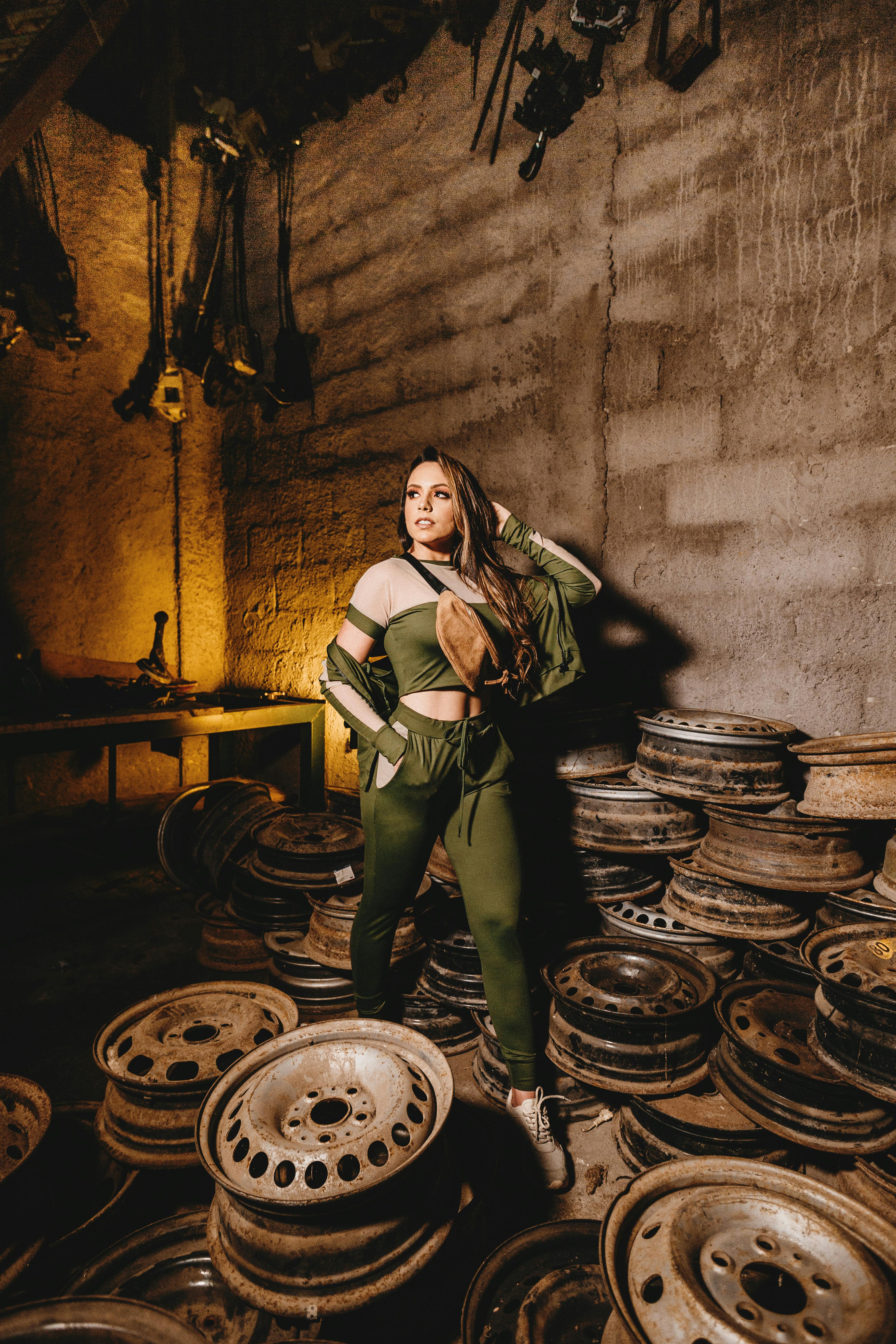 Woman Posing Inside A Room Of Vehicle Rims · Free Stock Photo