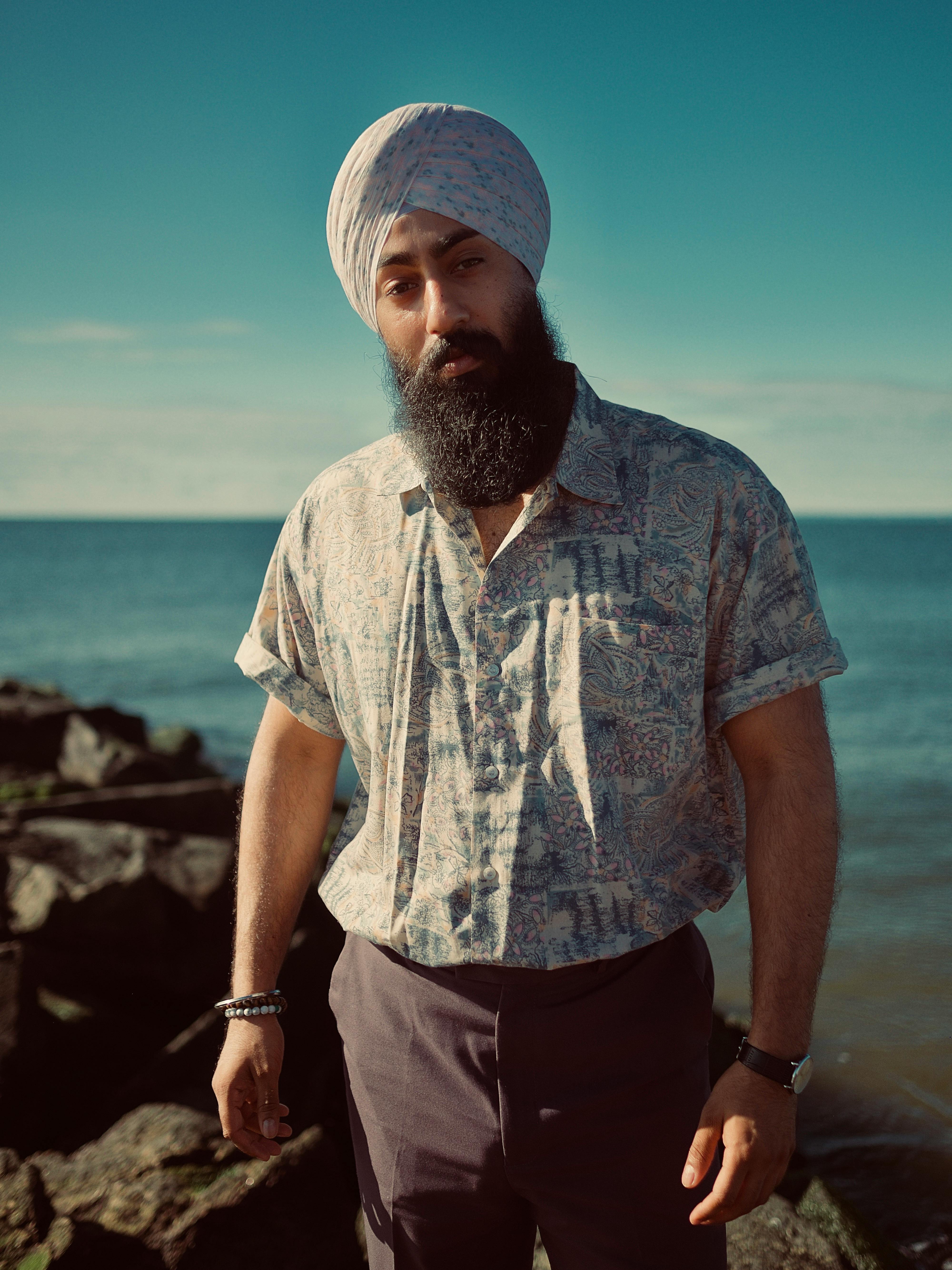 Man Wearing a Turban Standing Near Body of Water · Free Stock Photo