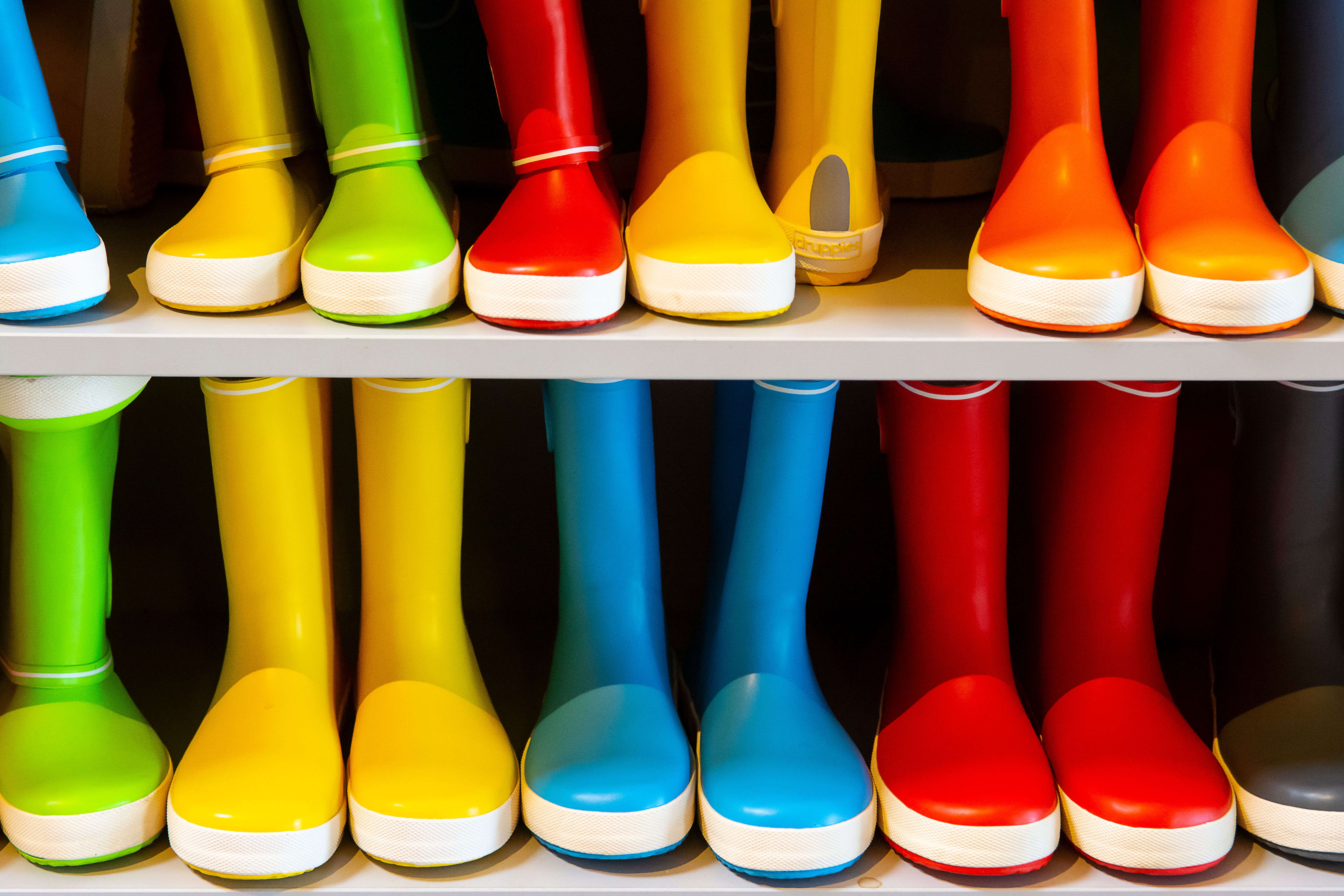 Brightly Colored Rain Boots Displayed on Shelf · Free Stock Photo