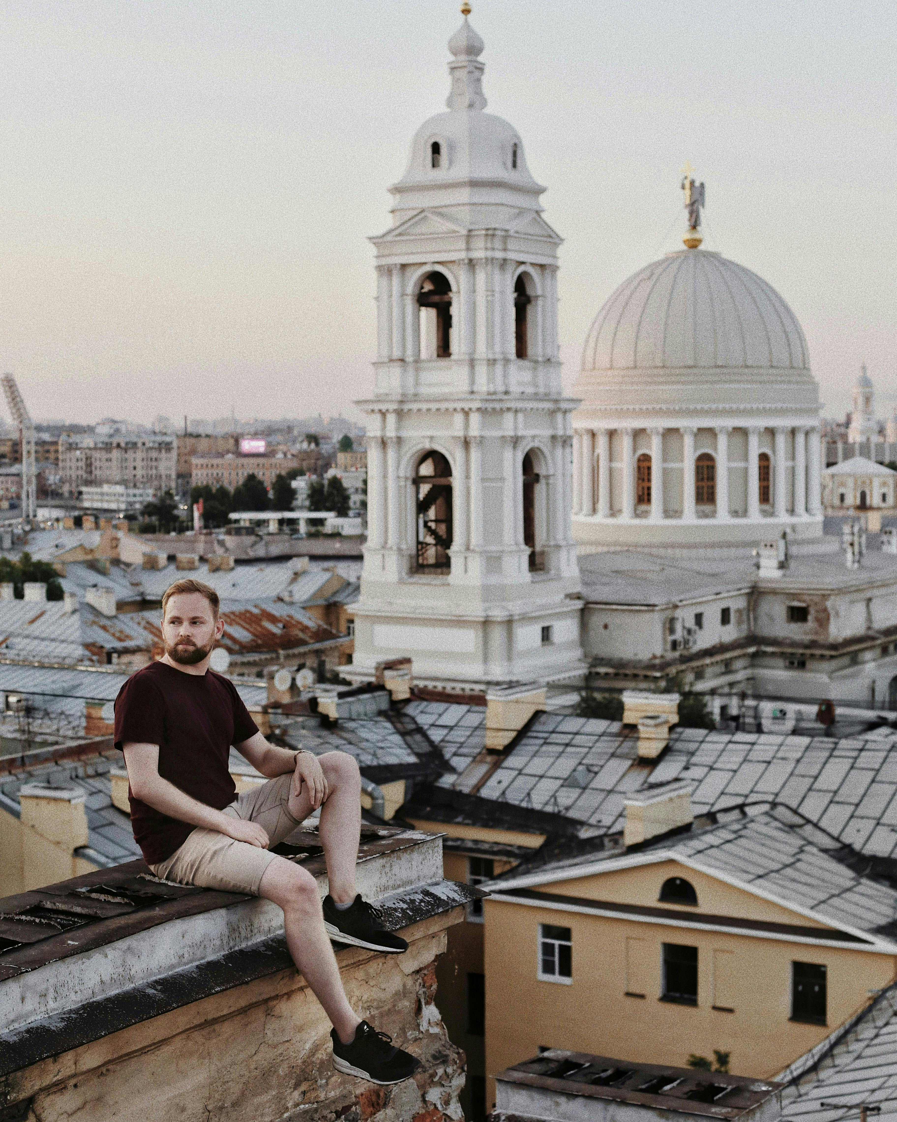 Young Man on Rooftop Overlooking Saint Petersburg · Free Stock Photo