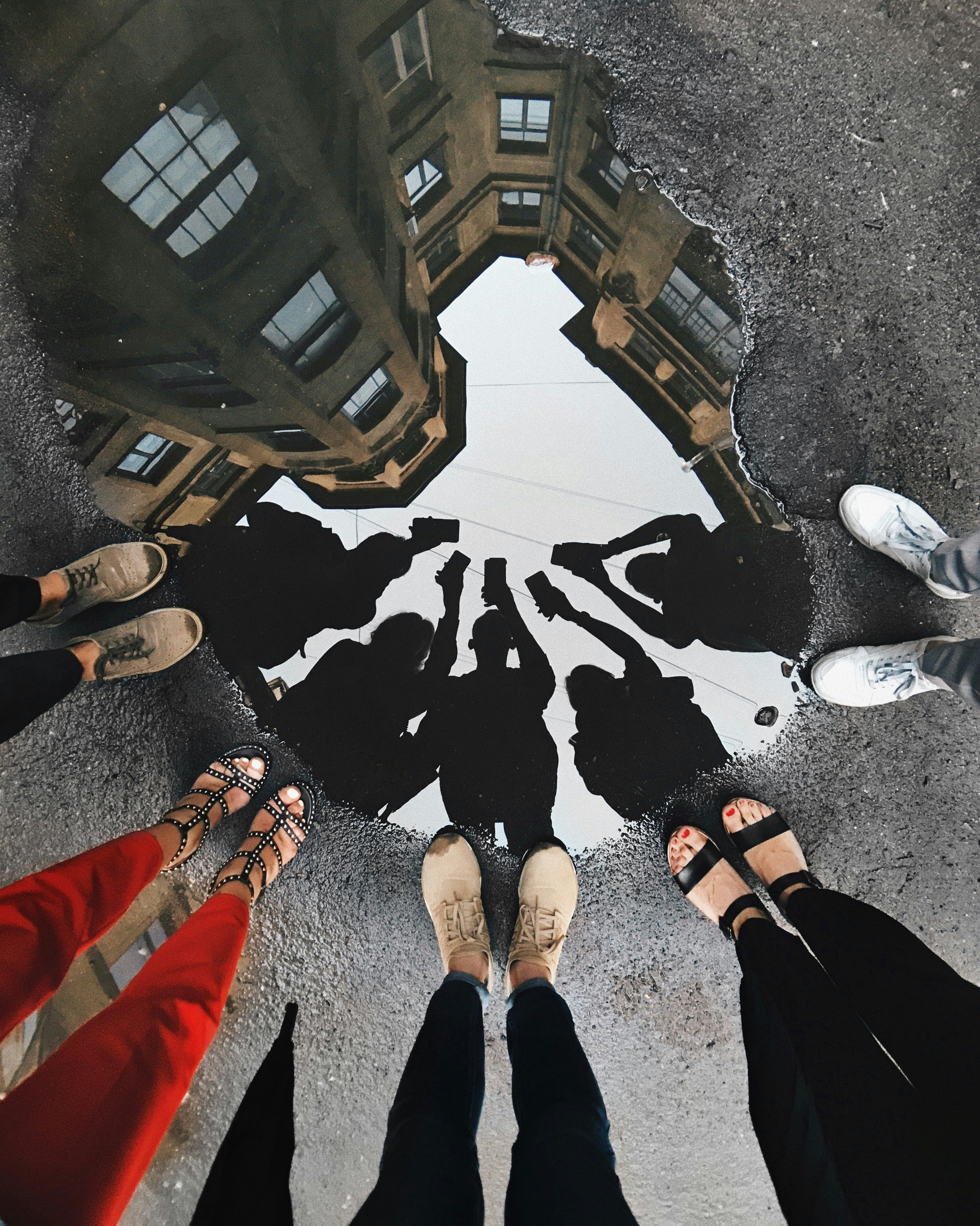 Creative Reflection of Group in Puddle · Free Stock Photo