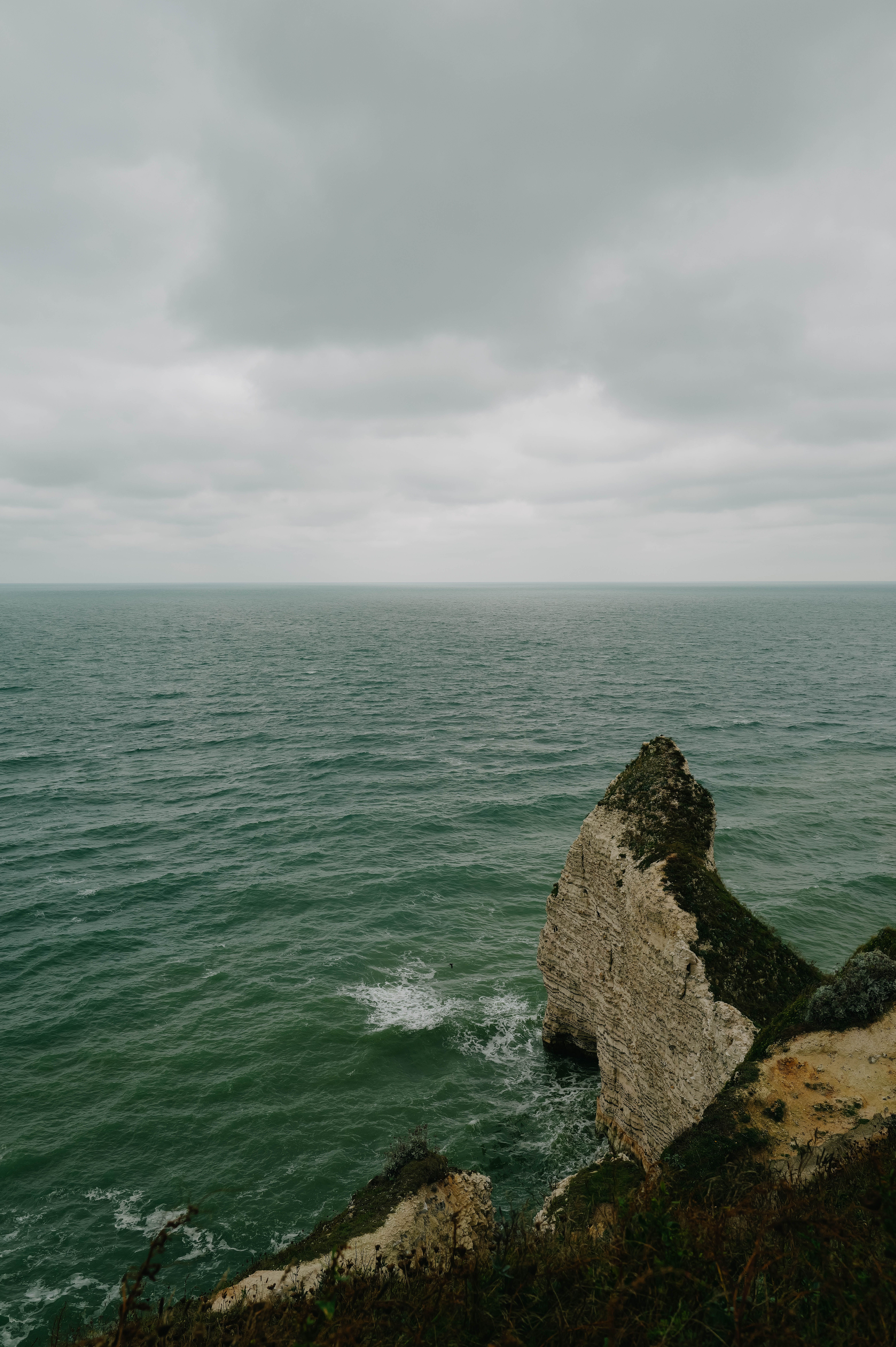 Dramatic Cliffside Overlooking Moody Ocean Scene · Free Stock Photo