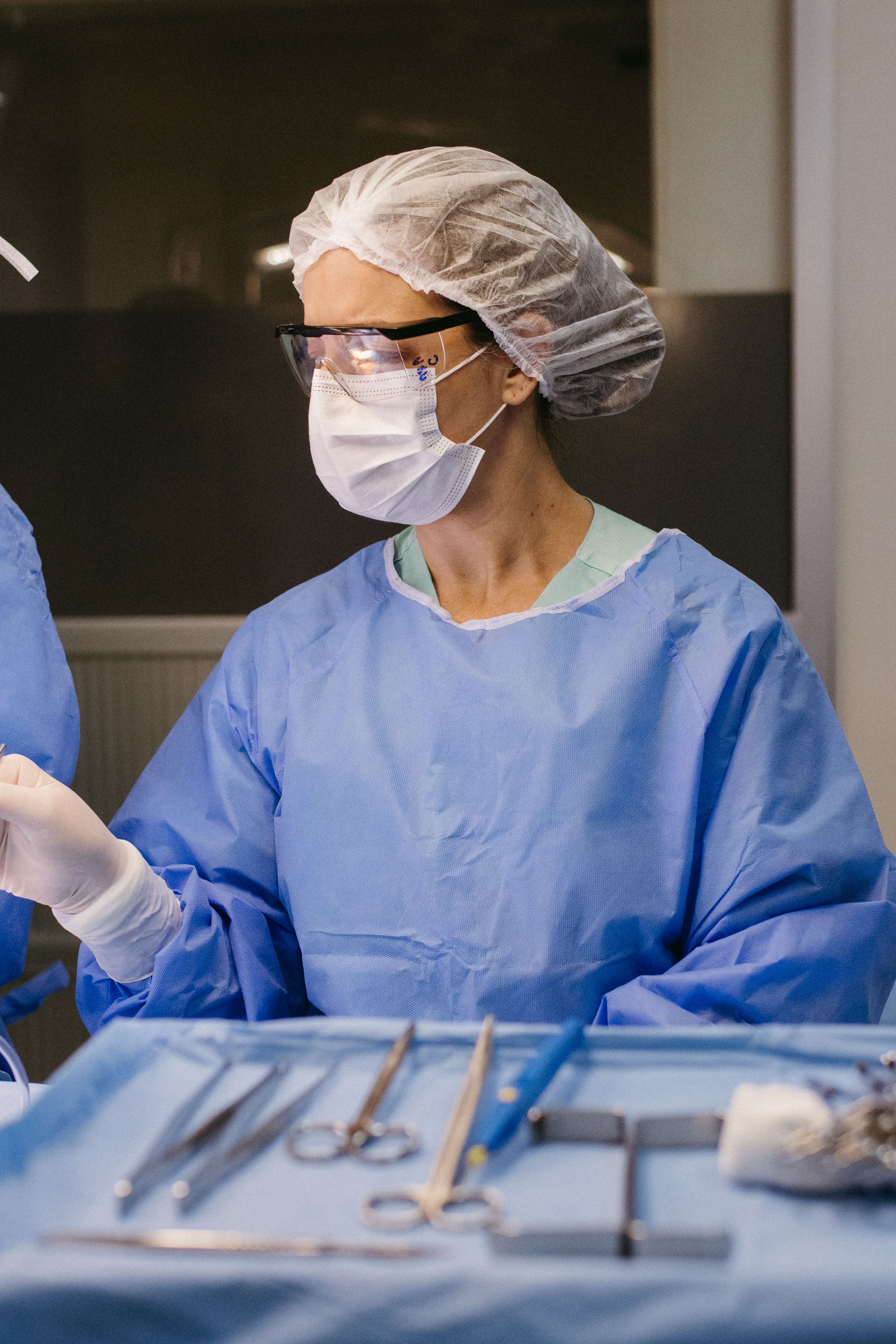 Surgeon in Operating Room with Surgical Tools · Free Stock Photo