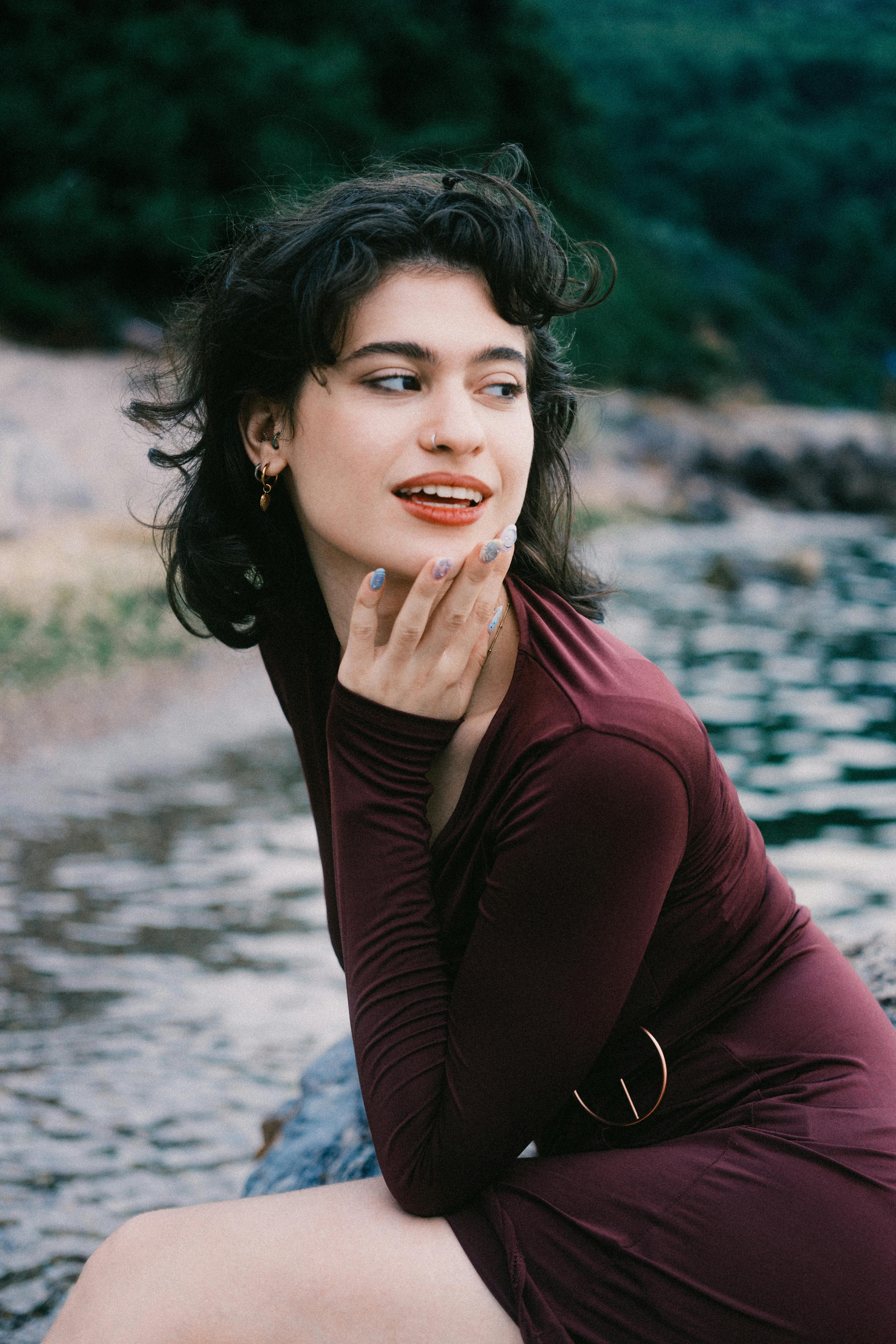 Woman in maroon dress by serene lakeside · Free Stock Photo