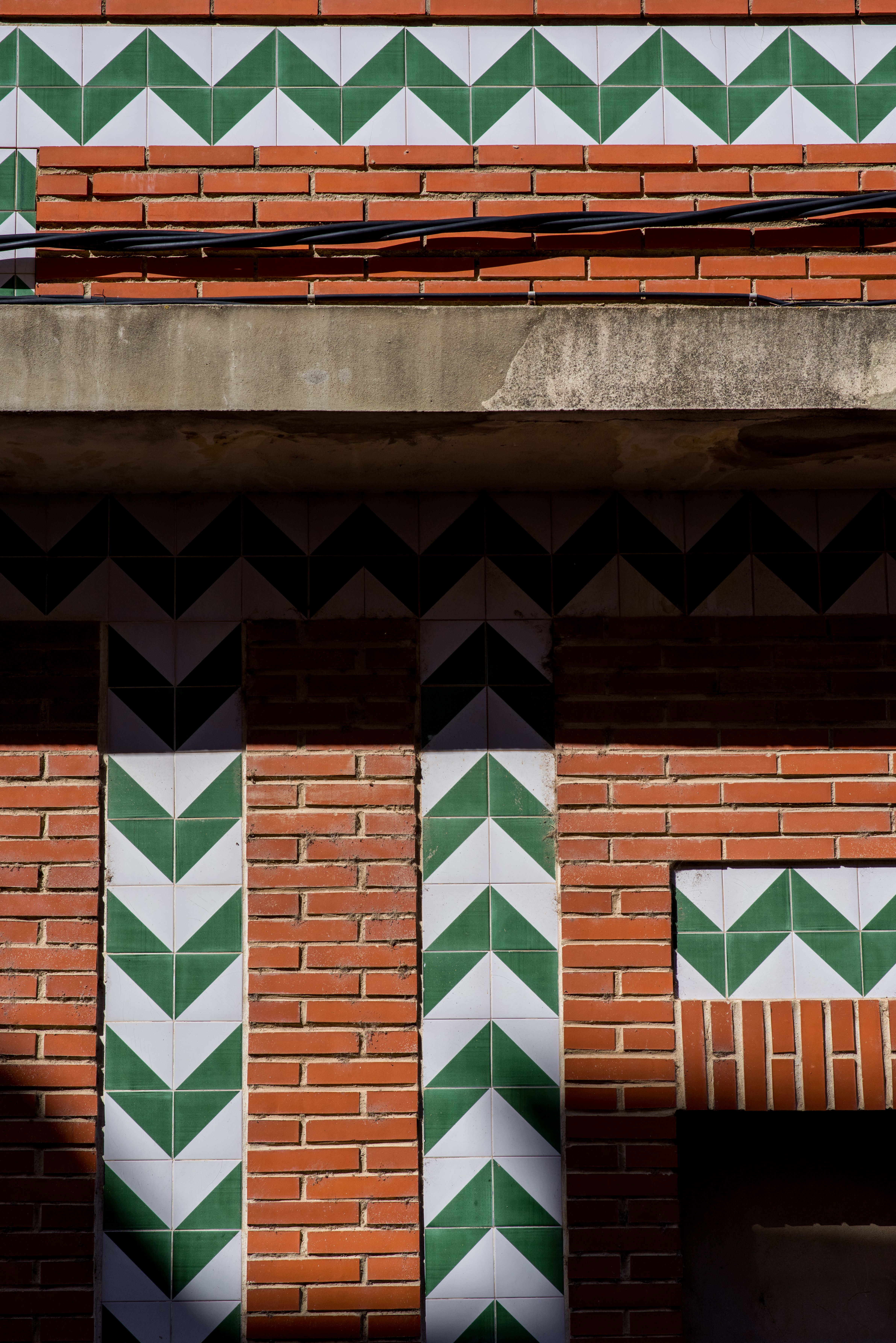 Exterior Brick Wall with Chevron Pattern Tiles · Free Stock Photo