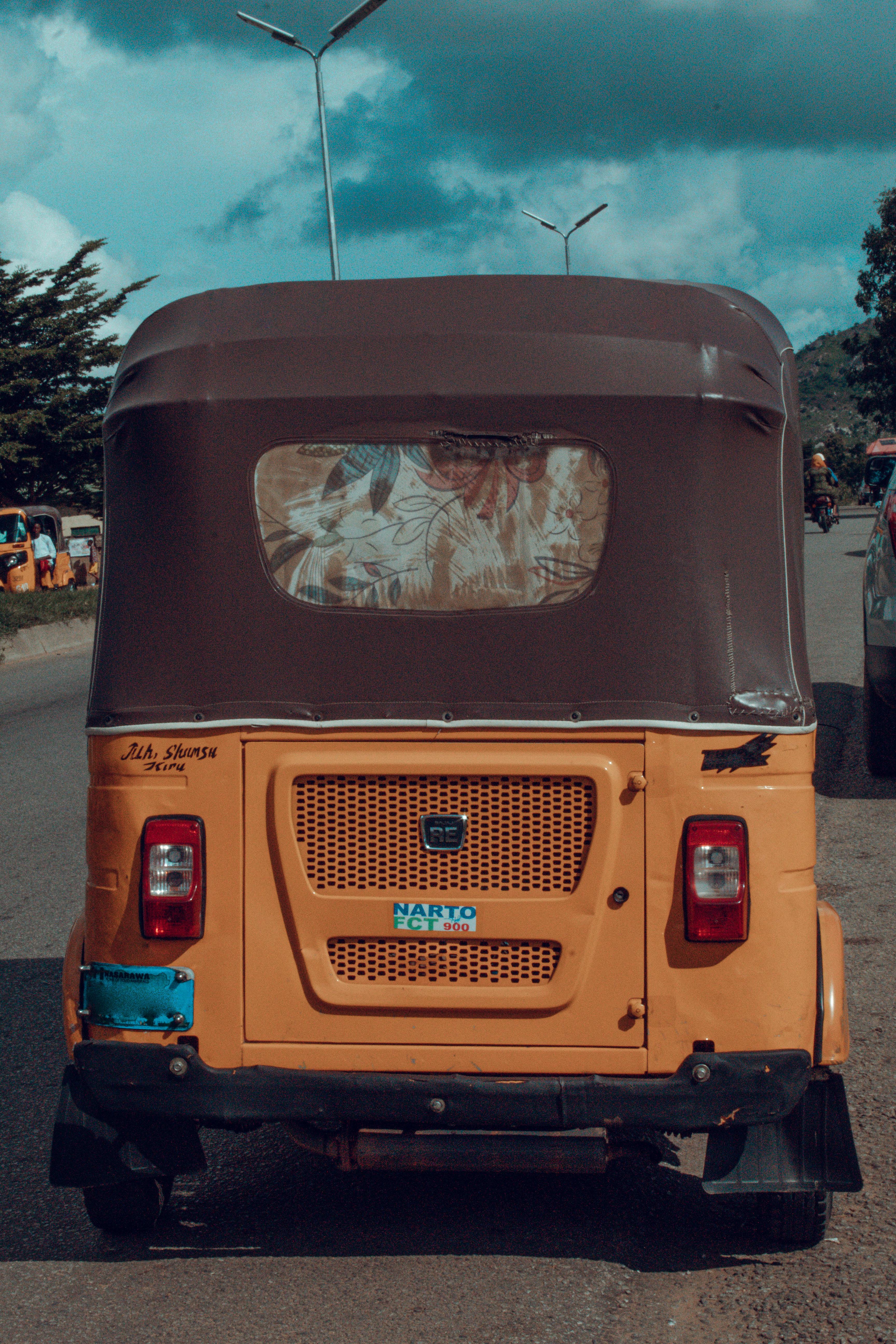 Yellow Auto Rickshaw on Abuja Road · Free Stock Photo
