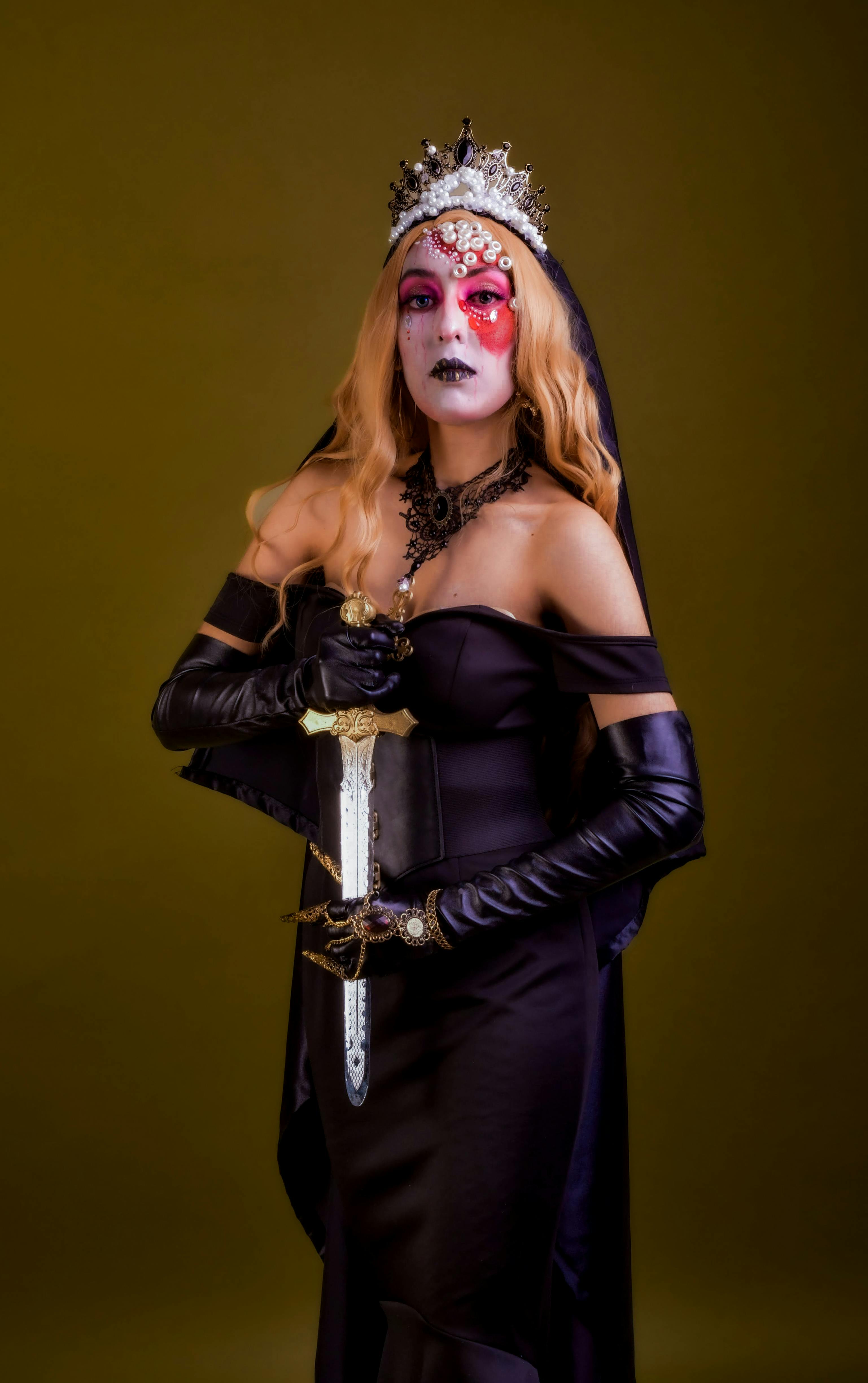 Dramatic Portrait of Cosplay Queen with Sword · Free Stock Photo