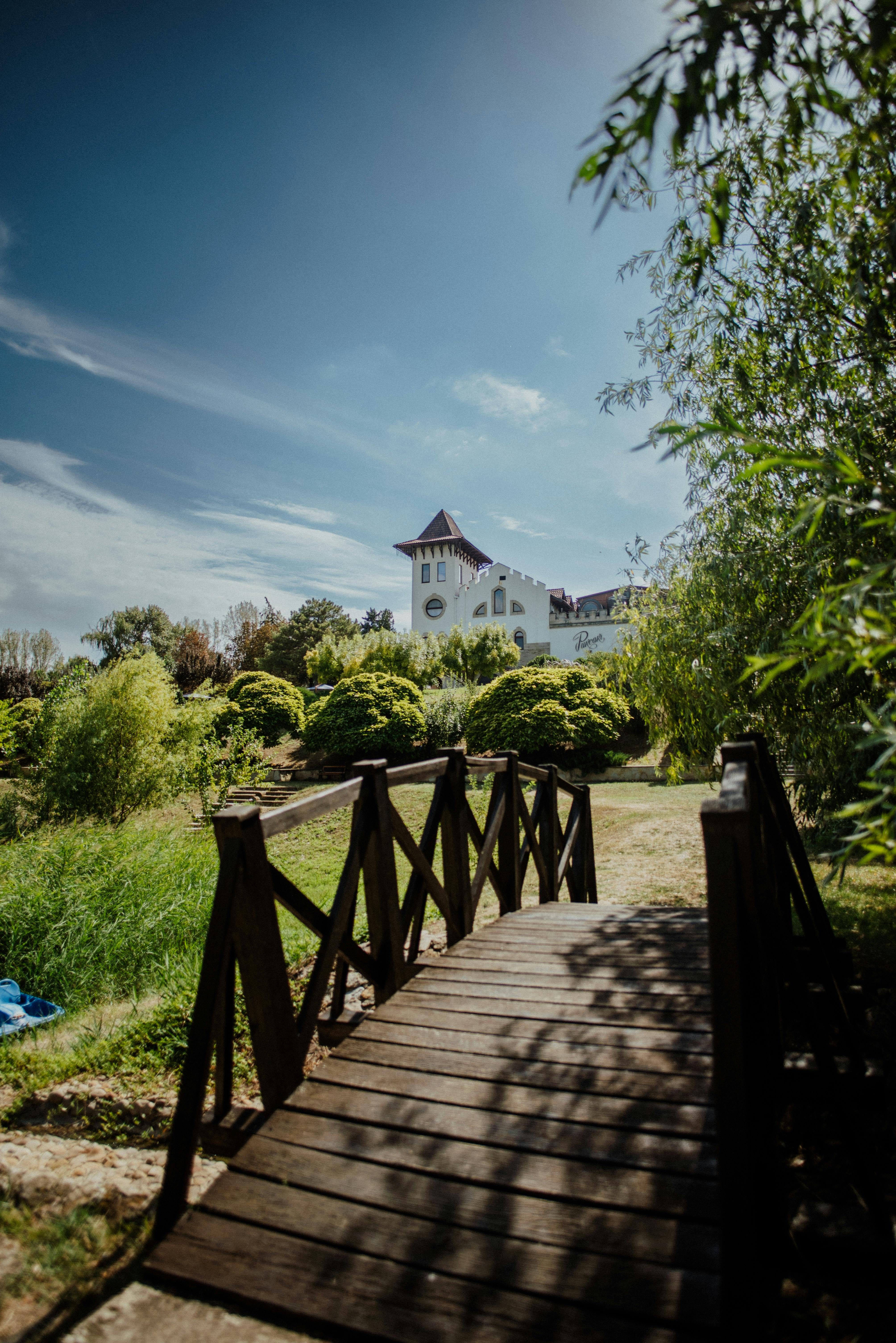 Charming Rural Bridge Leading to Picturesque Estate · Free Stock Photo