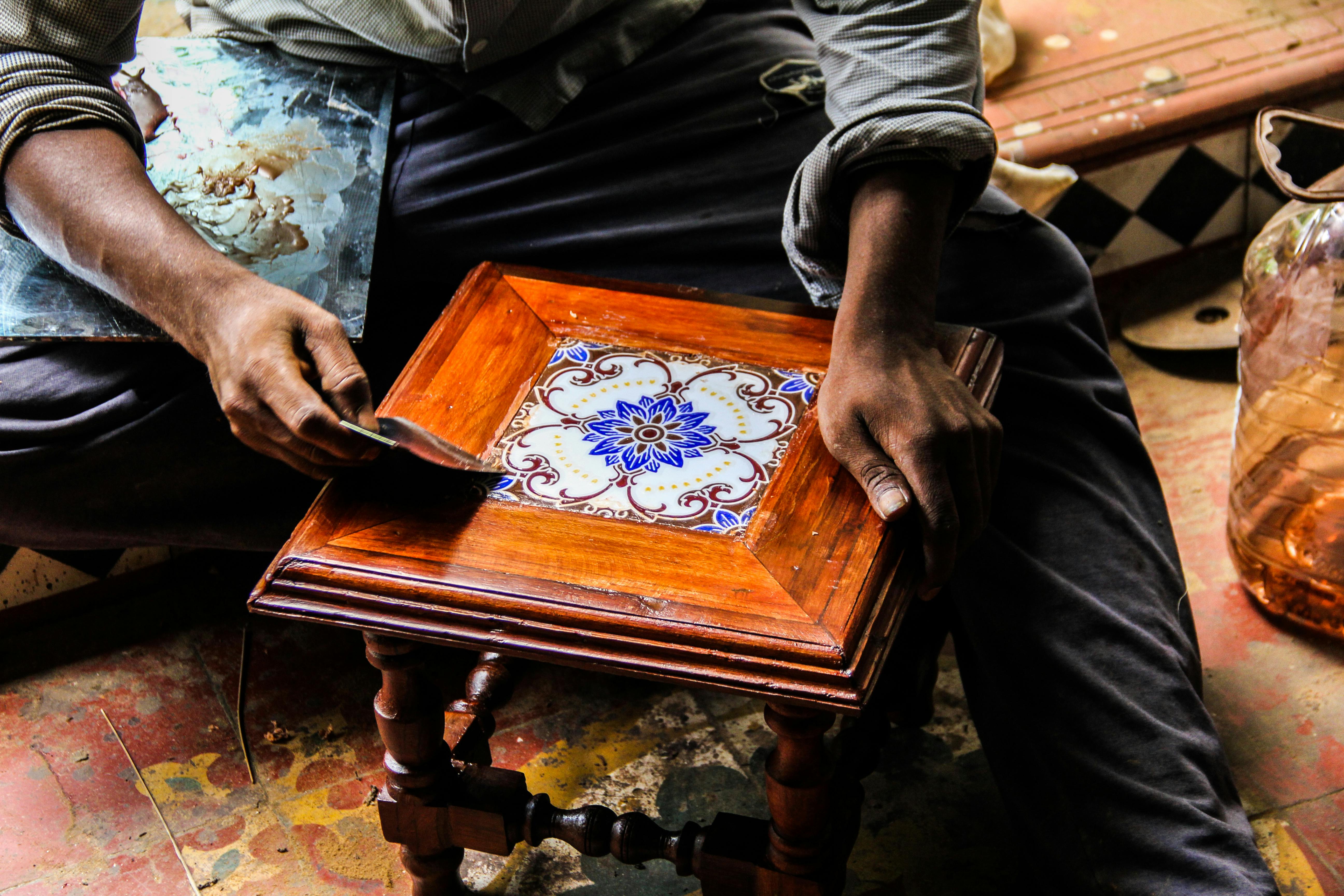 Artisan crafting decorative wooden panel with inlay · Free Stock Photo