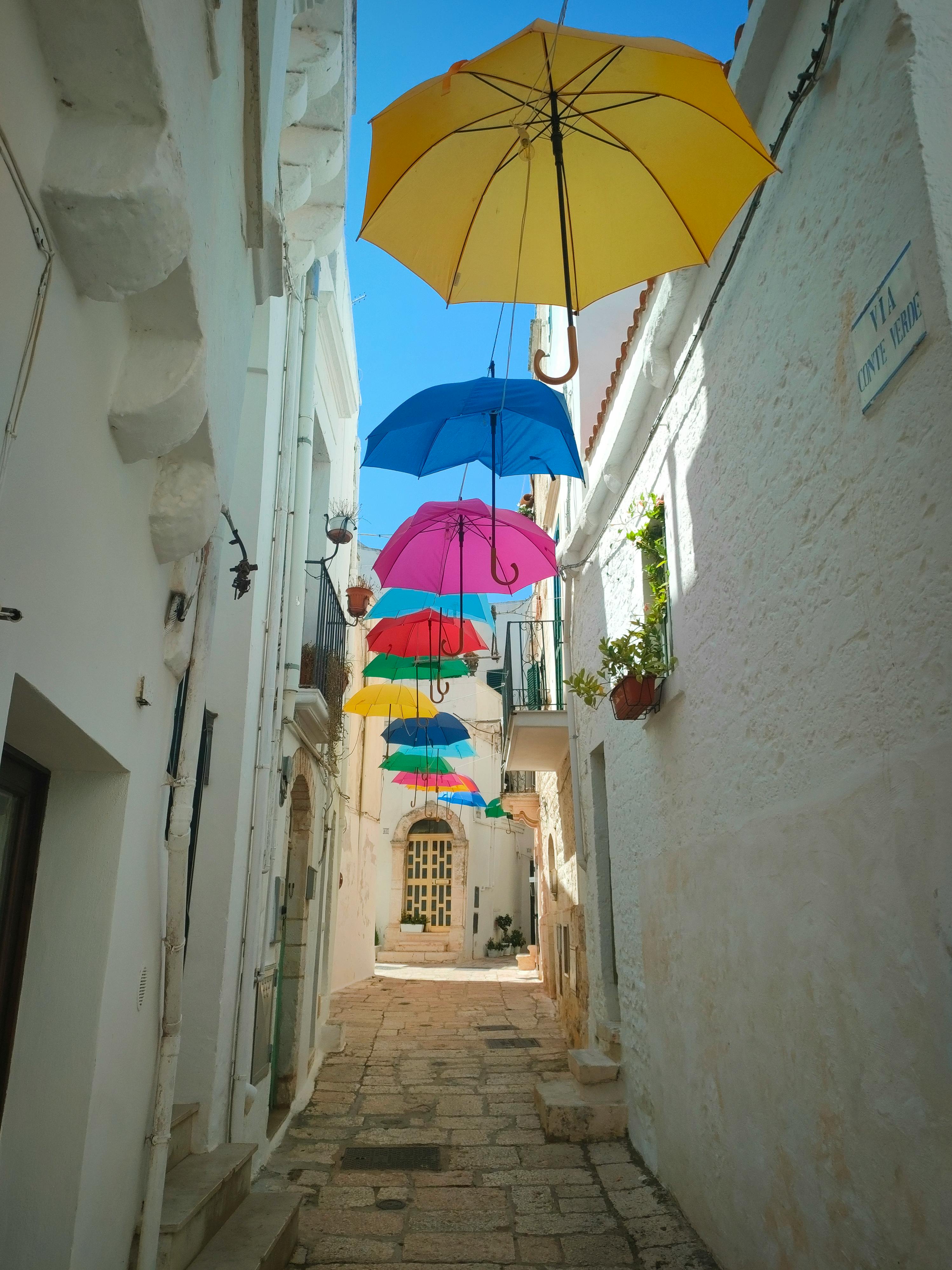 Colorful Umbrellas Hanging in Sunny Alleyway · Free Stock Photo