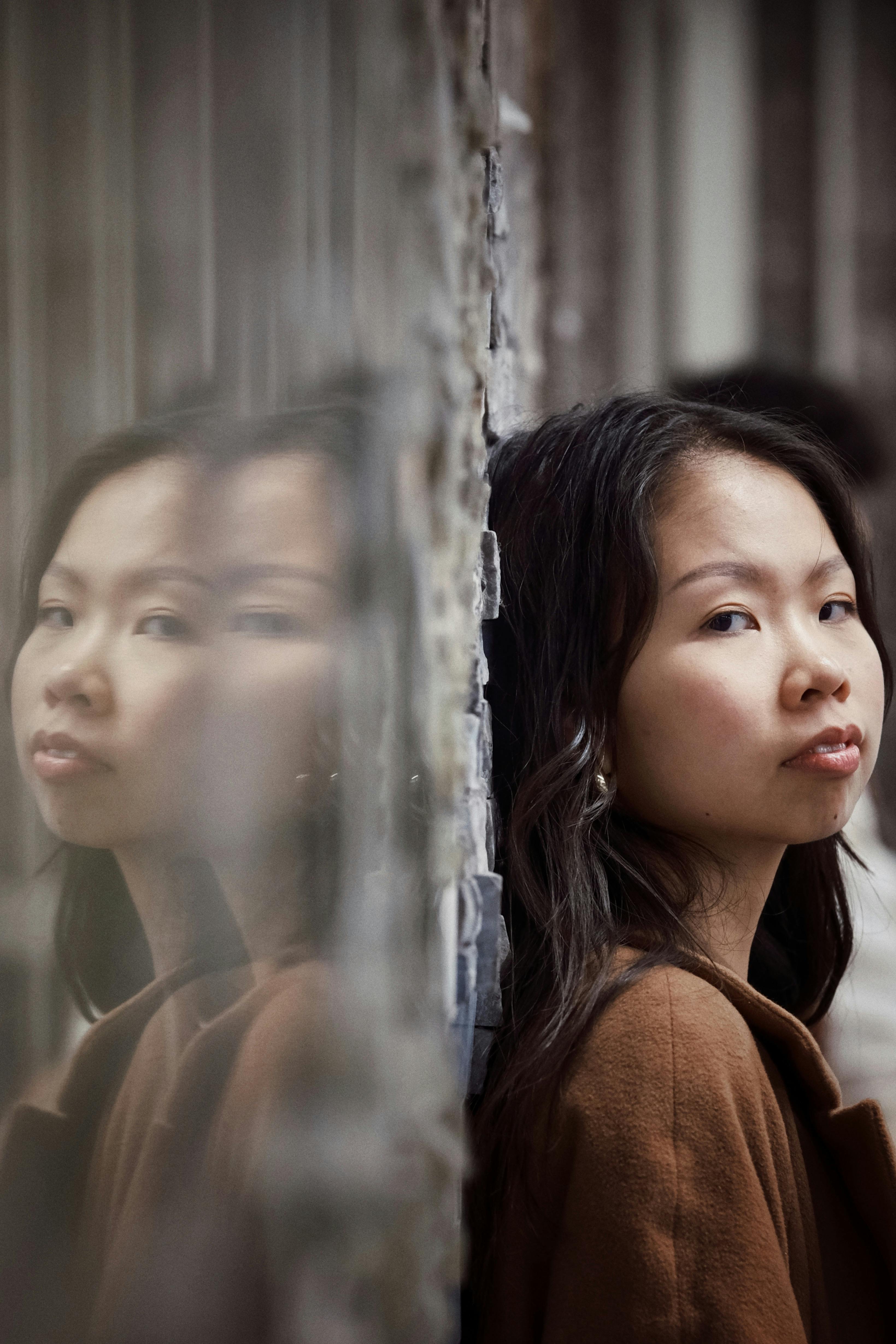 Reflective Portrait of a Woman in Urban Setting · Free Stock Photo