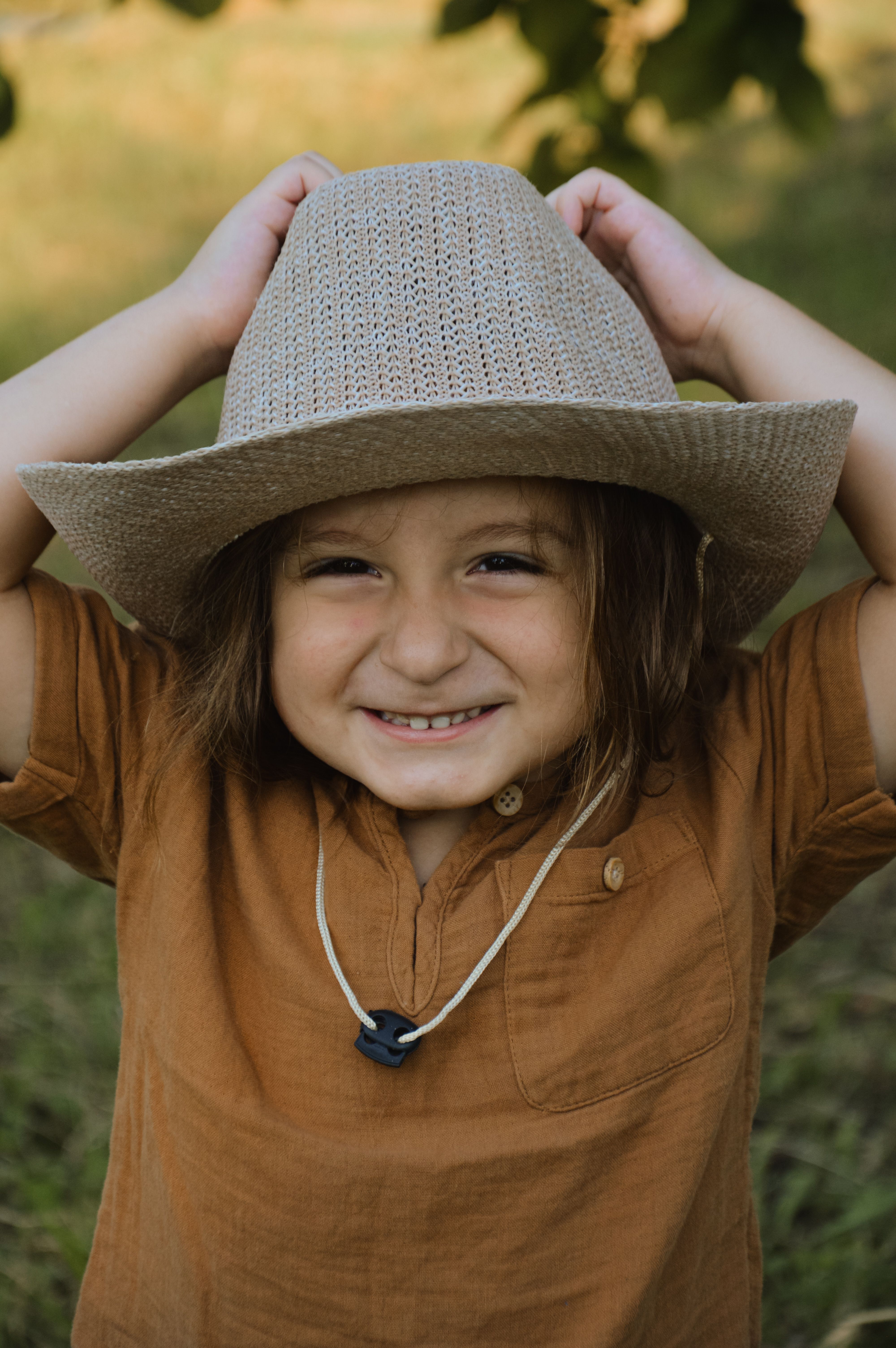 Smiling Child in Straw Hat Outdoors · Free Stock Photo