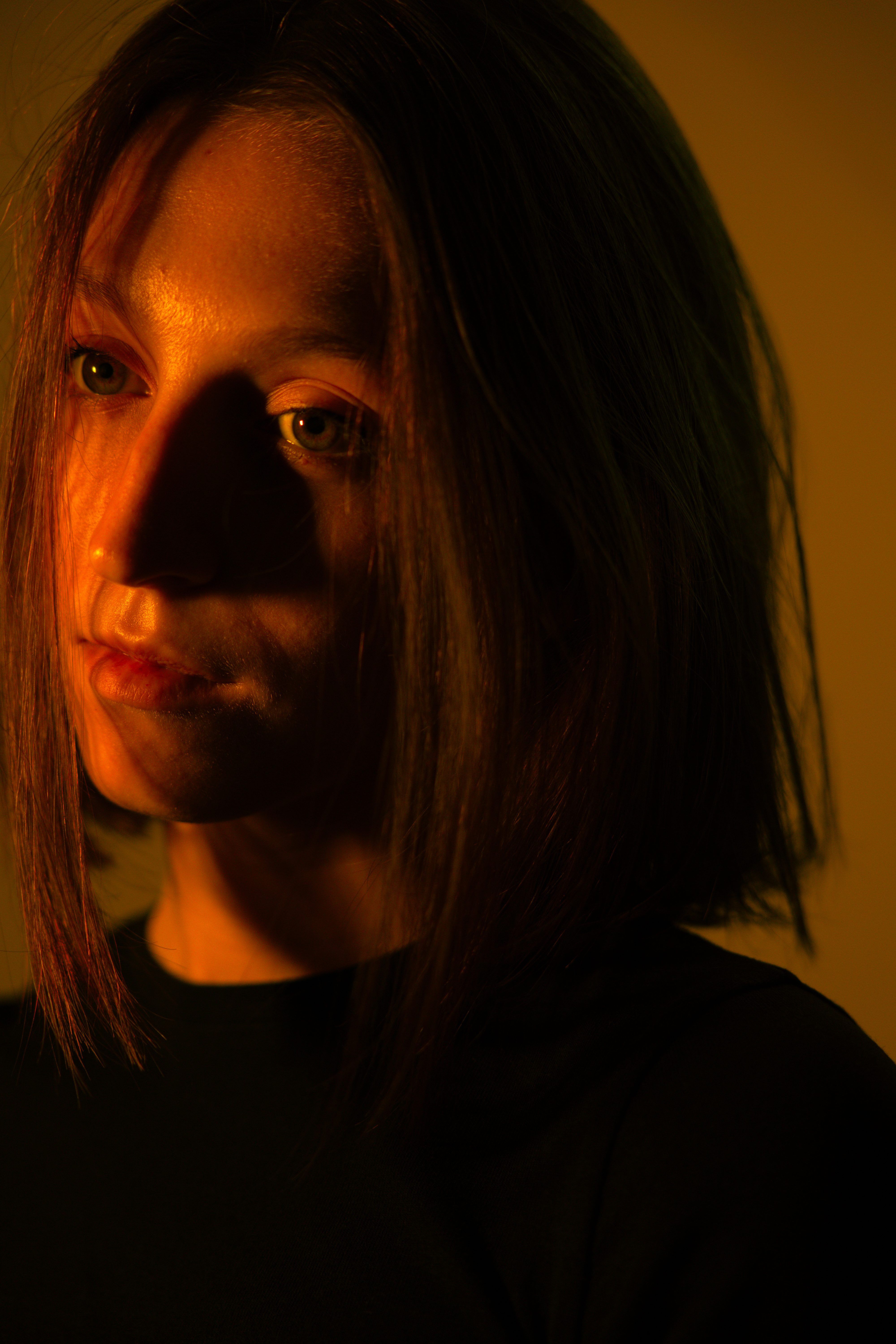 Moody Portrait of Young Woman in Warm Light · Free Stock Photo