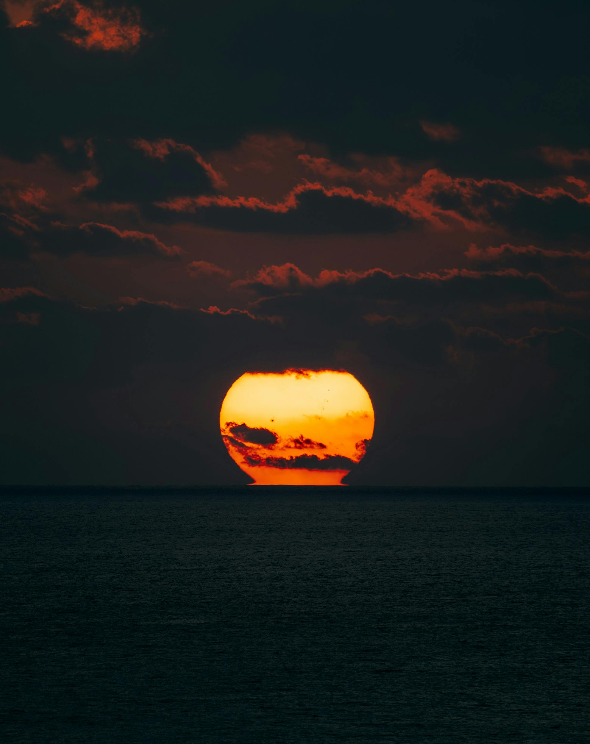 Stunning Orange Sunset Over Dark Ocean · Free Stock Photo