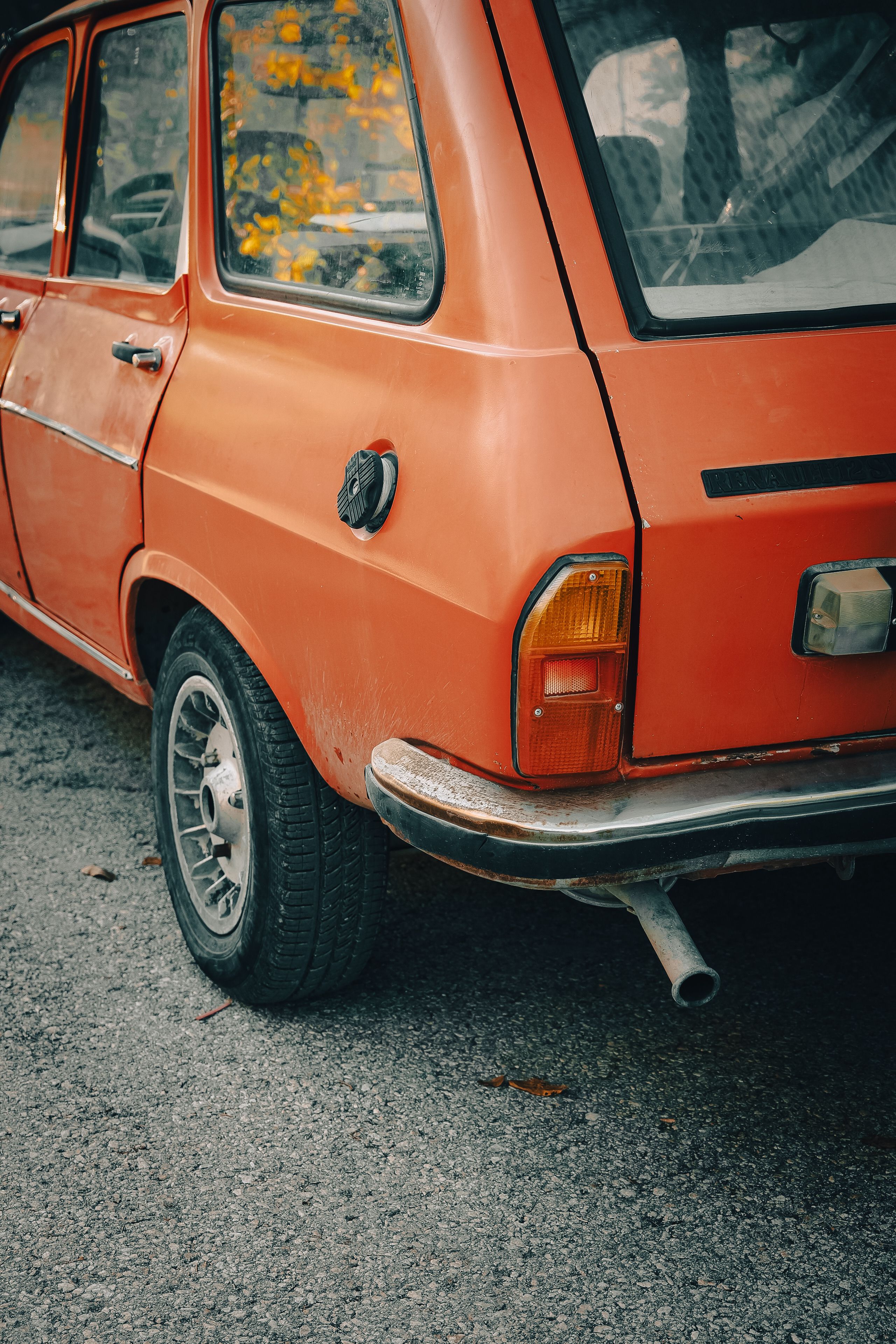 Vintage Orange Car on Pavement with Autumn Leaves · Free Stock Photo