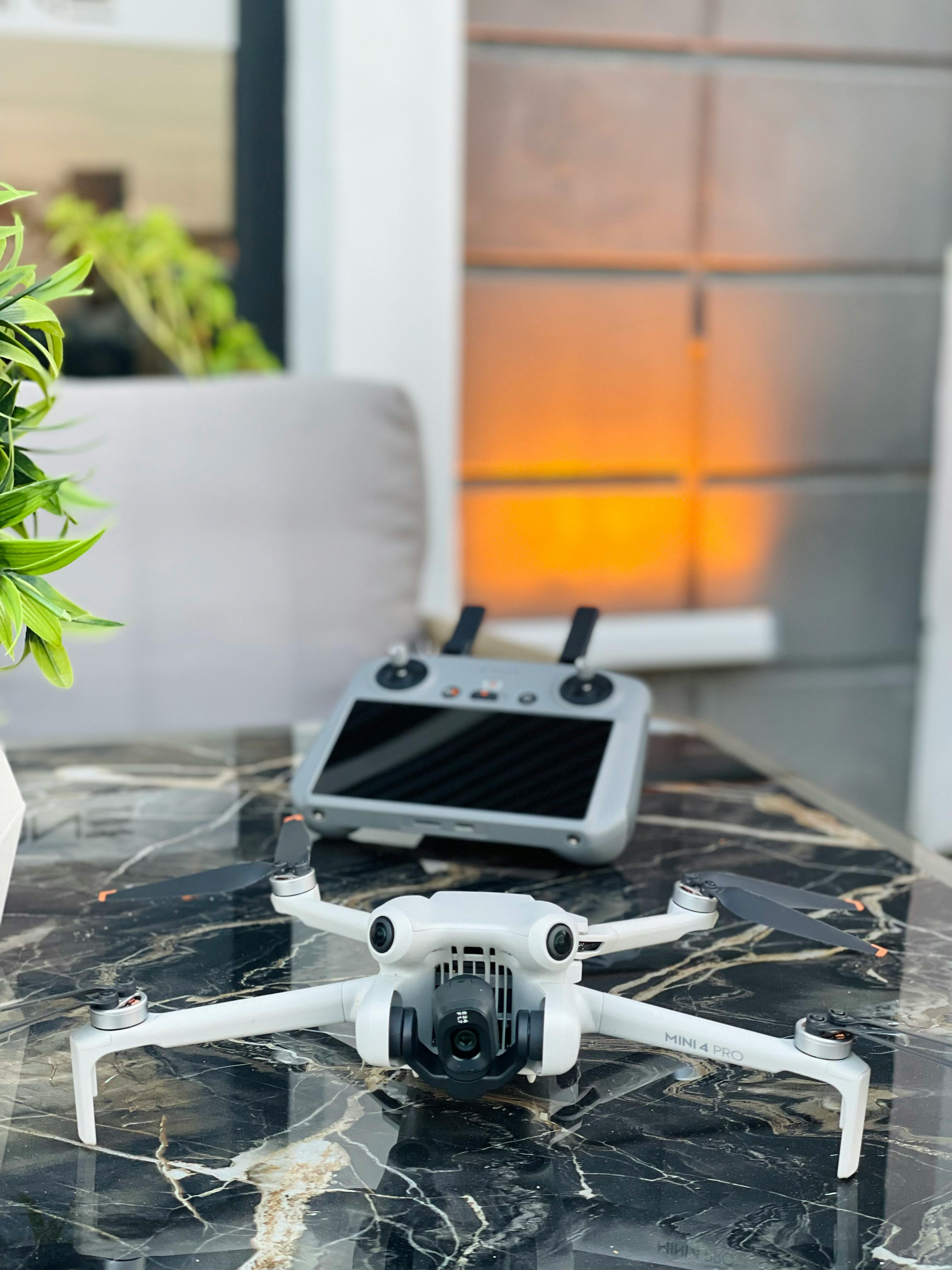 Compact Drone and Controller on Marble Table · Free Stock Photo