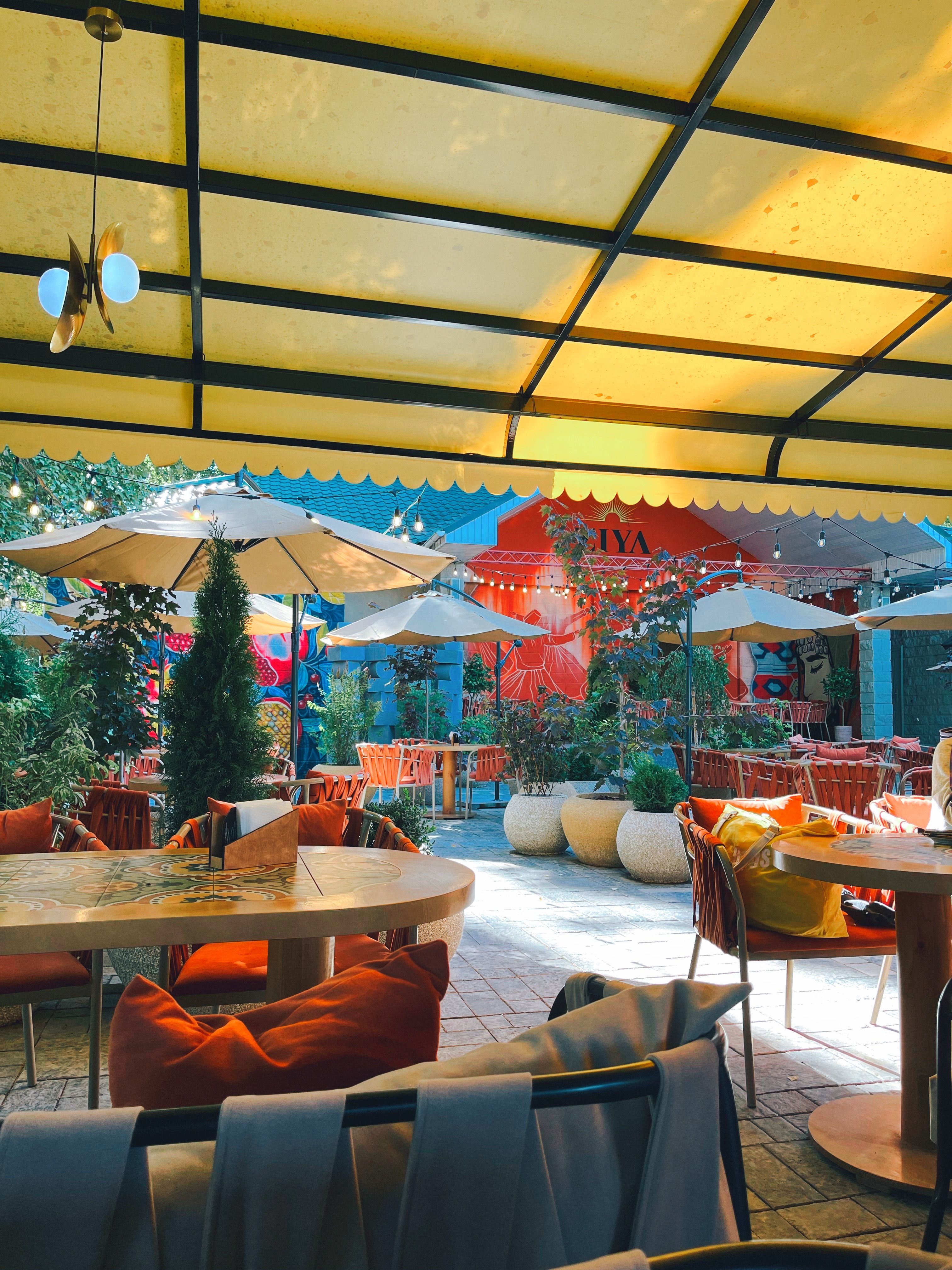 Sunny Outdoor Café with Colorful Decor · Free Stock Photo