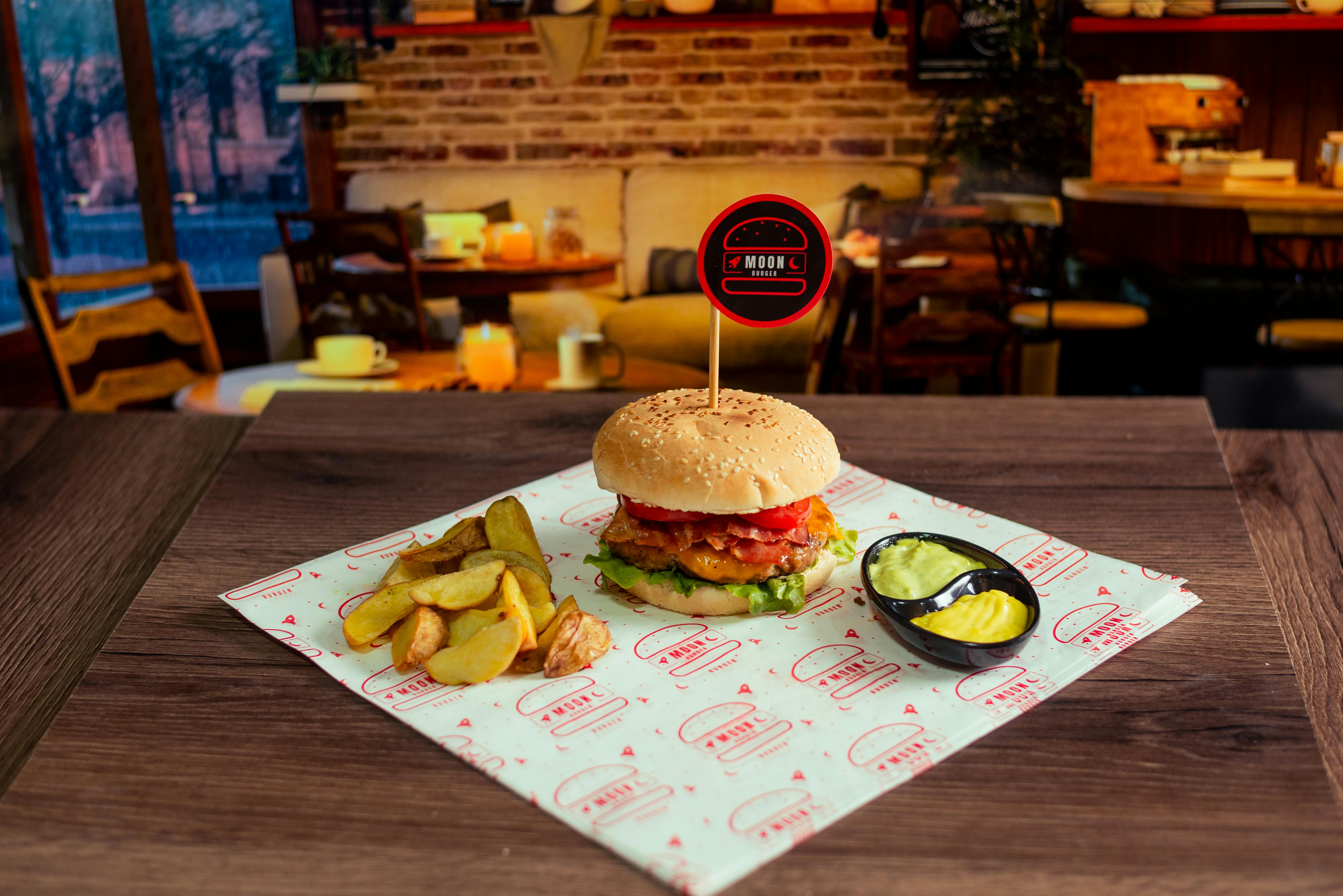 Delicious Burger in Cozy Cafe Setting · Free Stock Photo