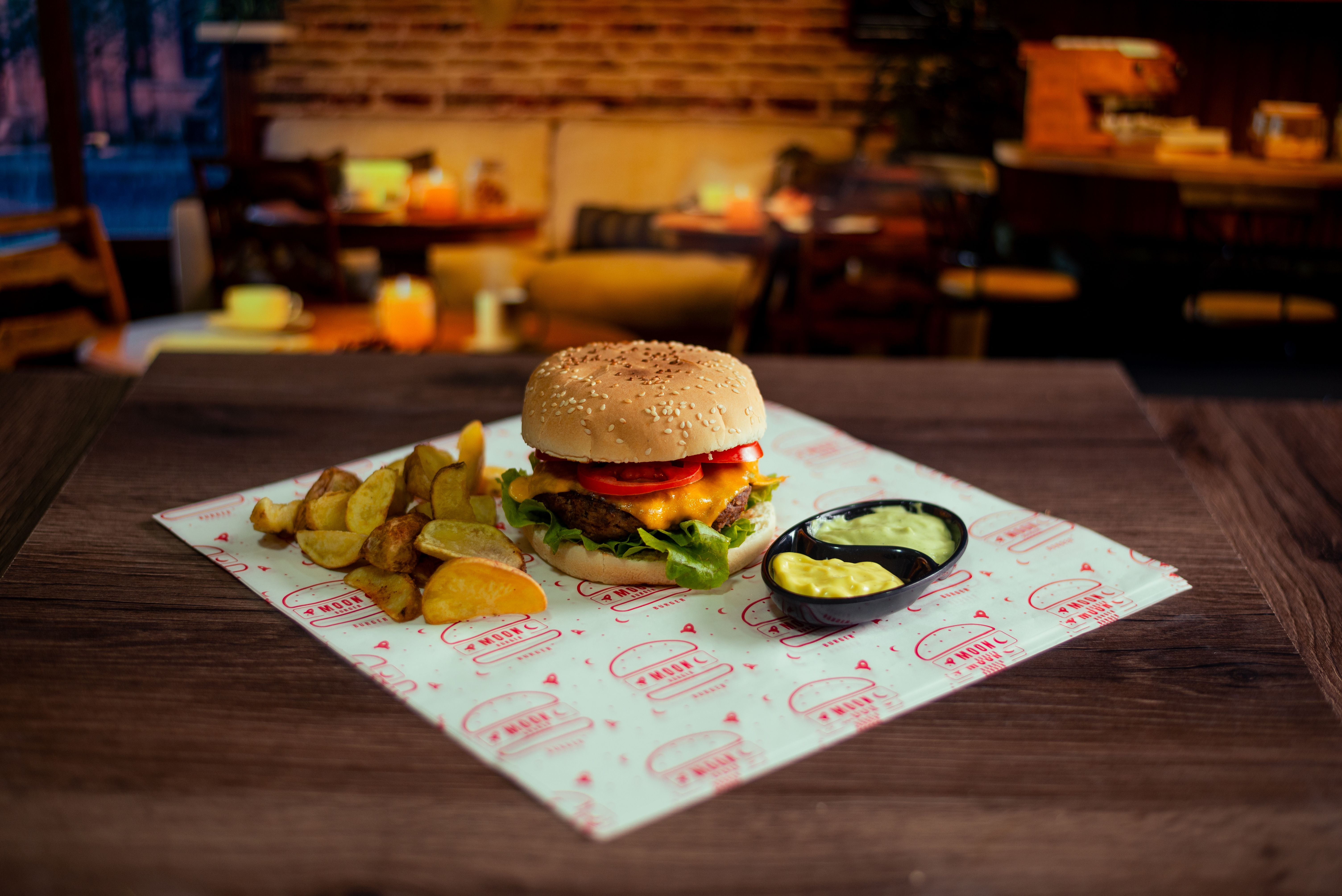Delicious Cheeseburger with Wedges in Cozy Cafe · Free Stock Photo