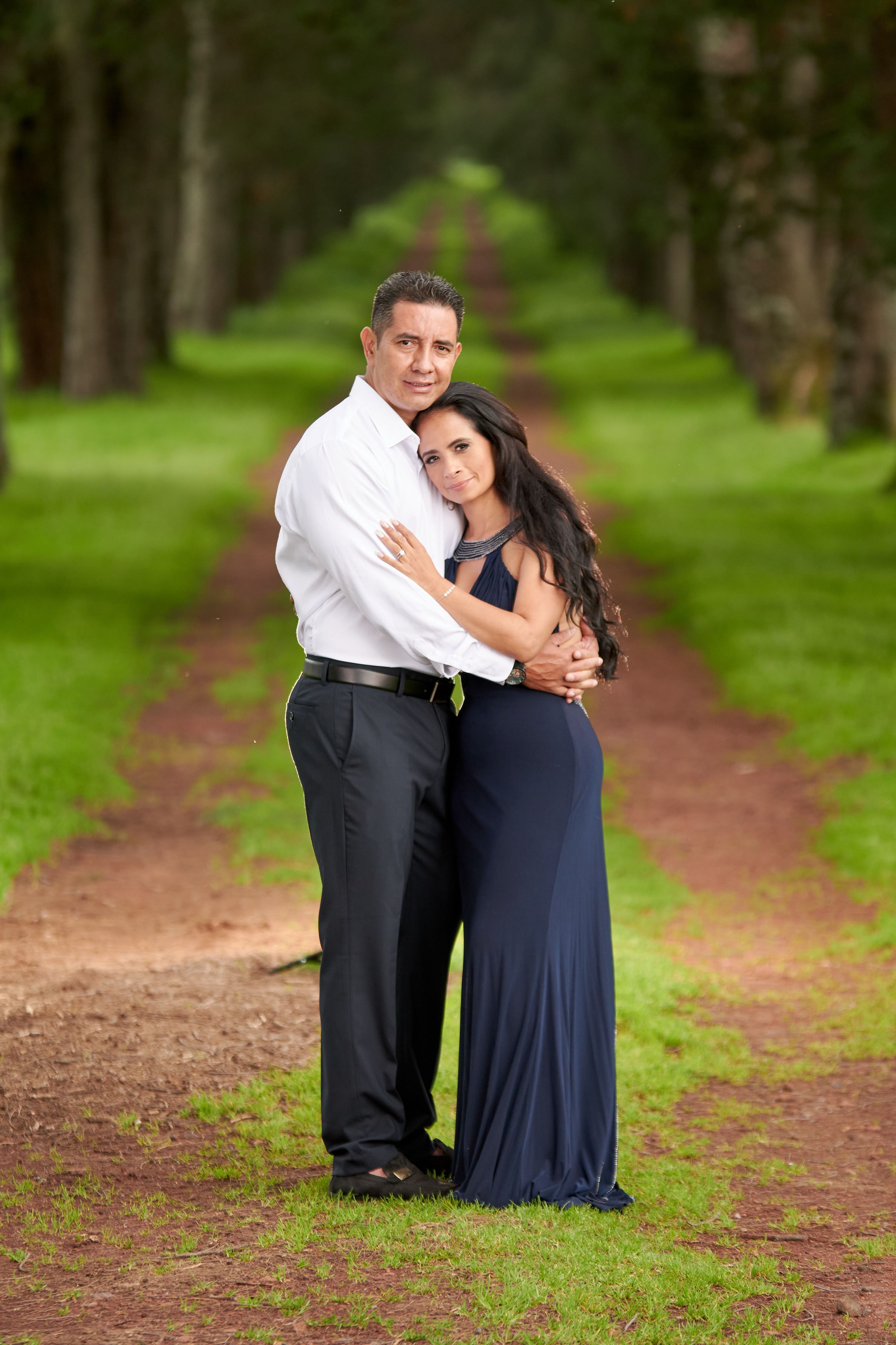 Romantic Couple Embracing on Tree-Lined Path · Free Stock Photo