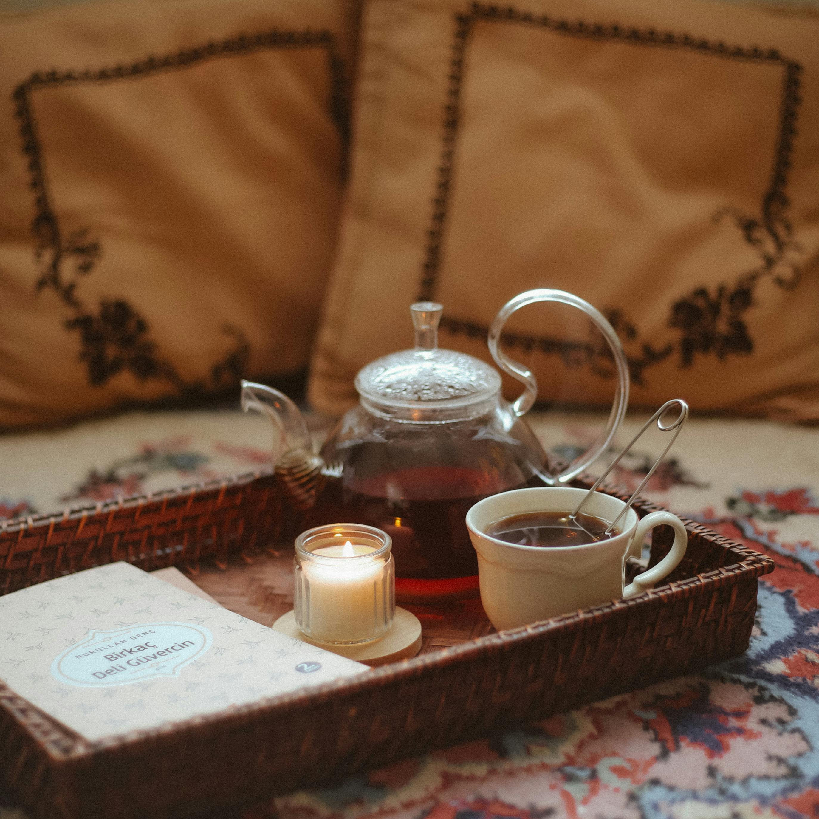 Cozy Tea Time Setup with Candle and Book · Free Stock Photo
