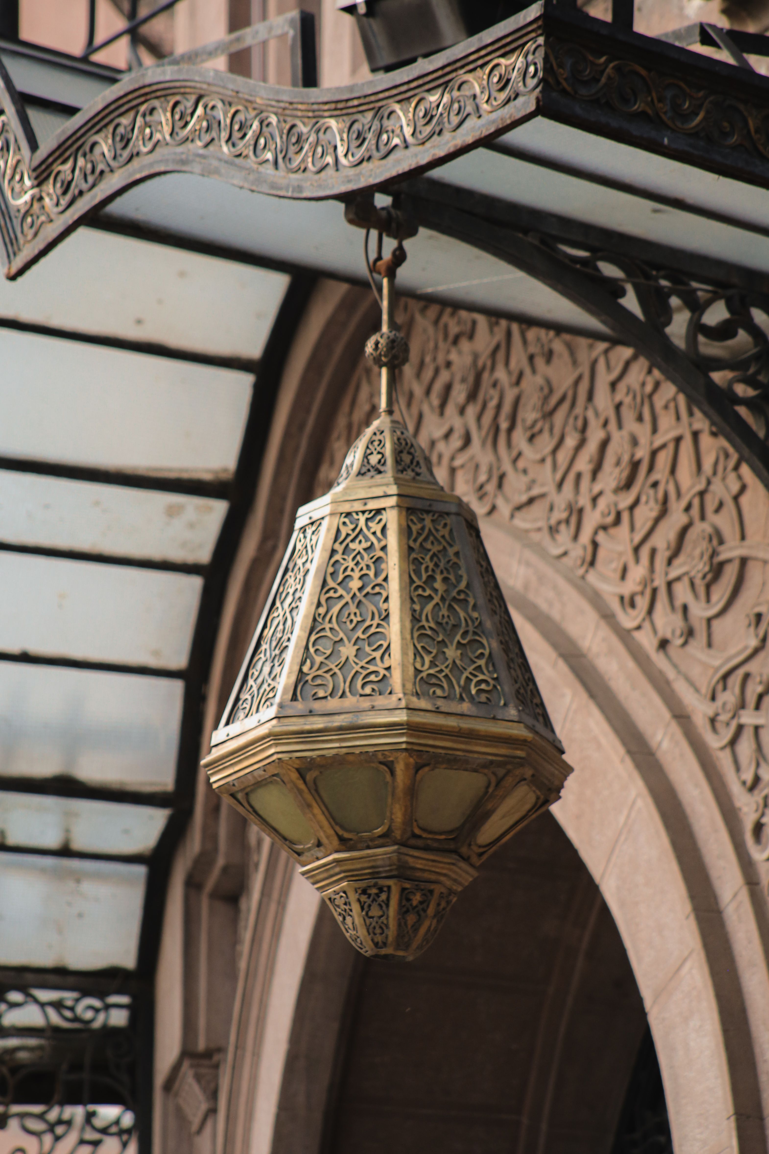 Ornate Vintage Lantern on Building Facade · Free Stock Photo