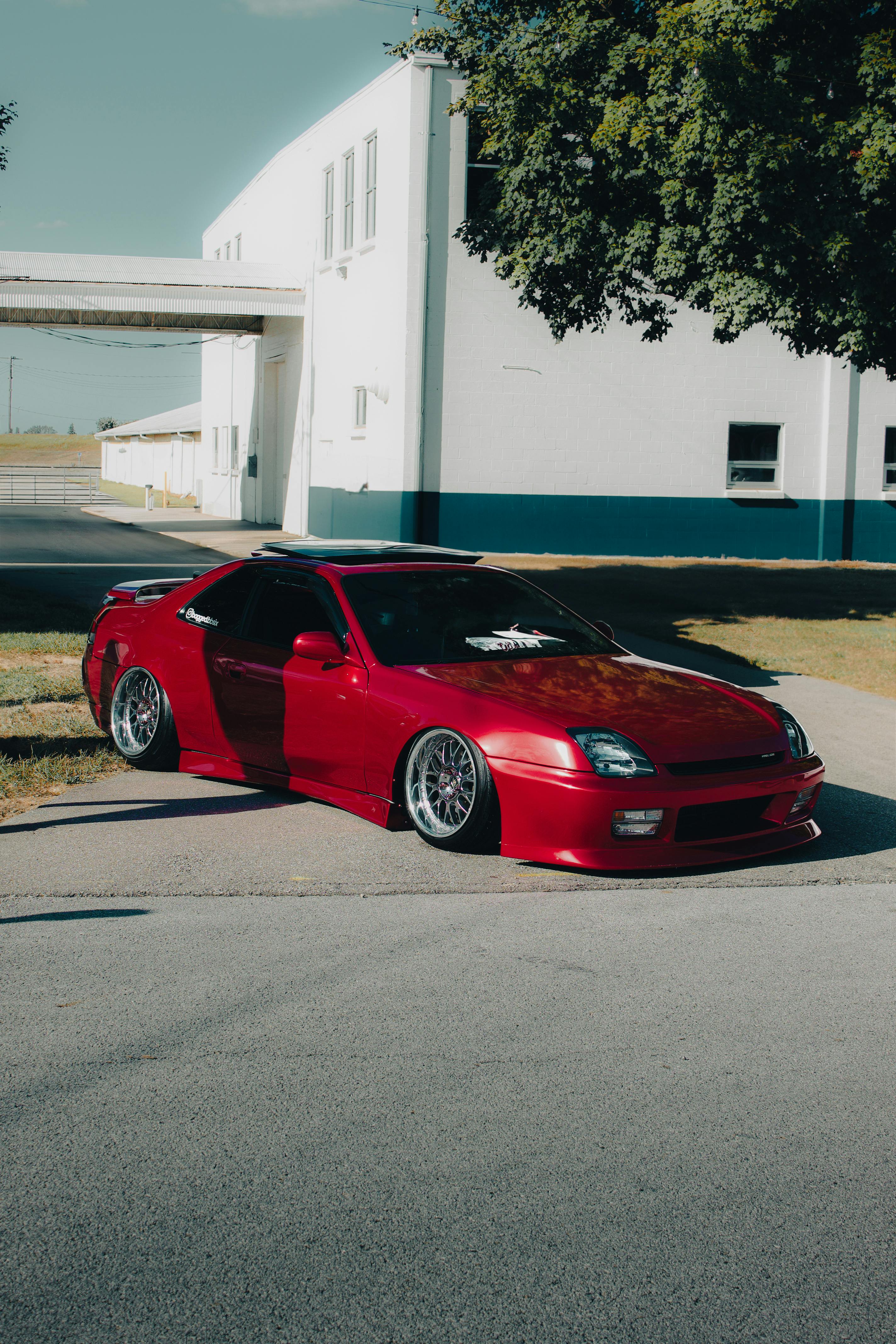 Slammed Red Honda Prelude in Urban Setting · Free Stock Photo