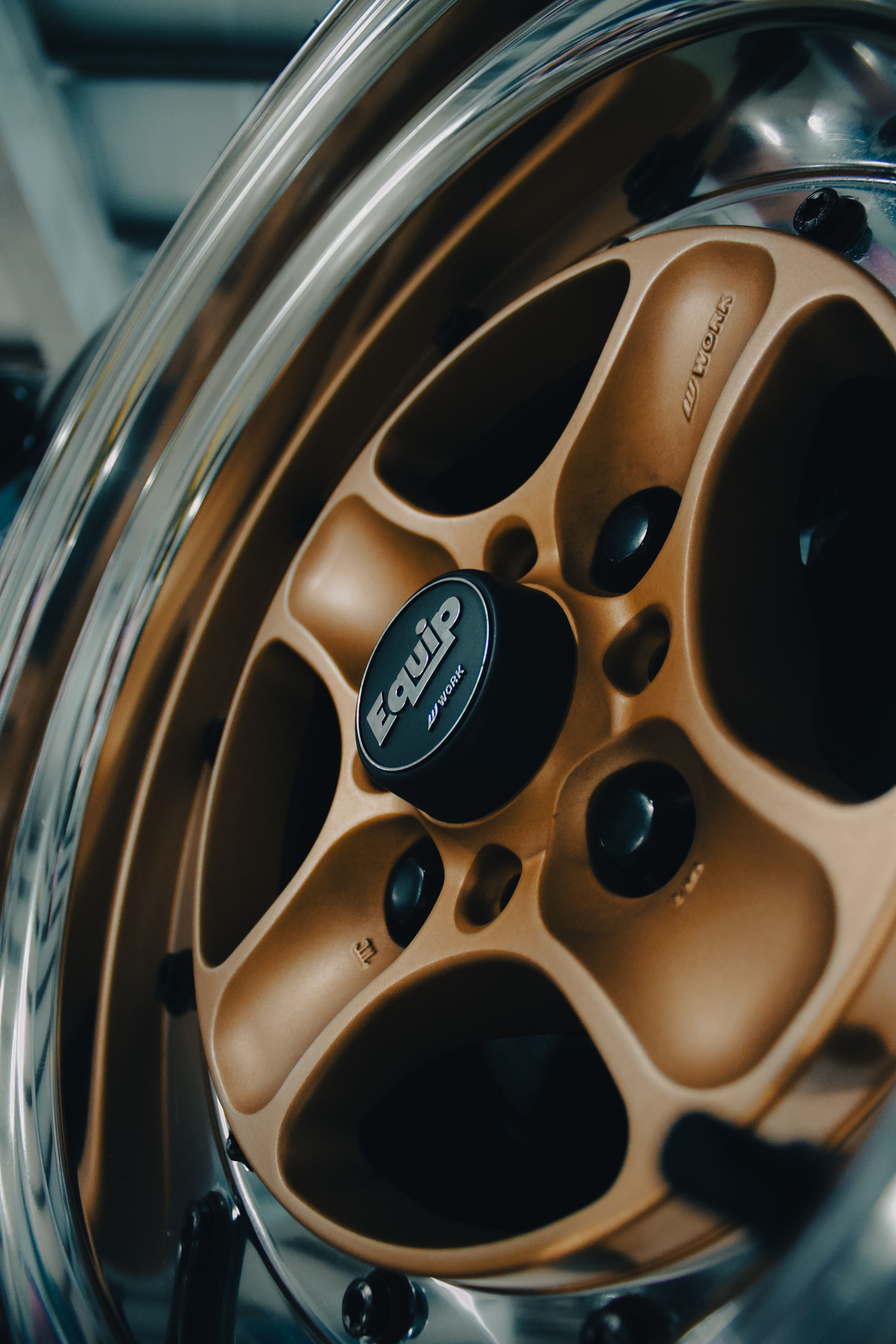 Close-up of Bronze Car Wheel with Equip Logo · Free Stock Photo