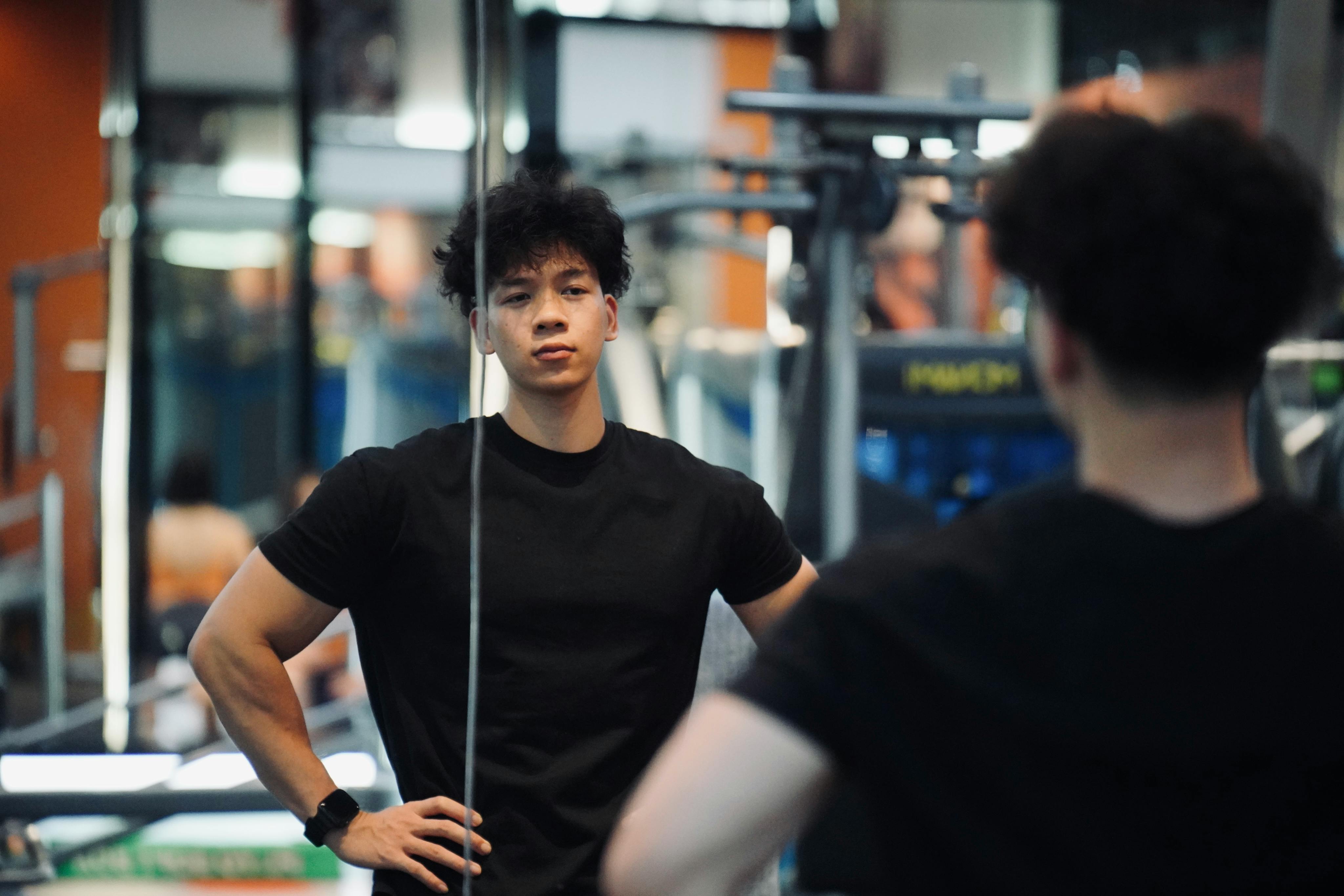 Young Man Reflecting in Gym Mirror · Free Stock Photo