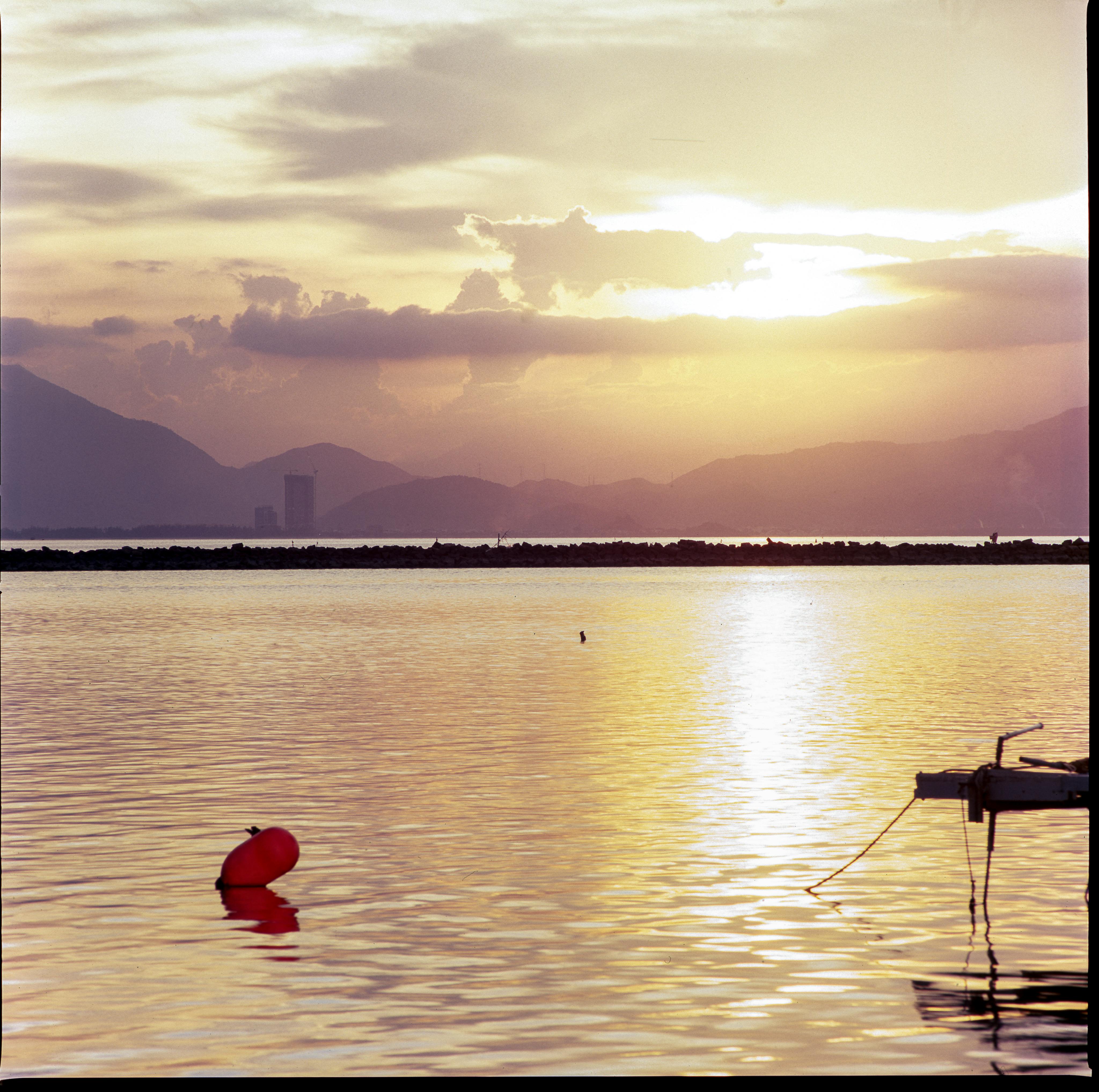 Serene Coastal Sunset with Vibrant Buoy · Free Stock Photo