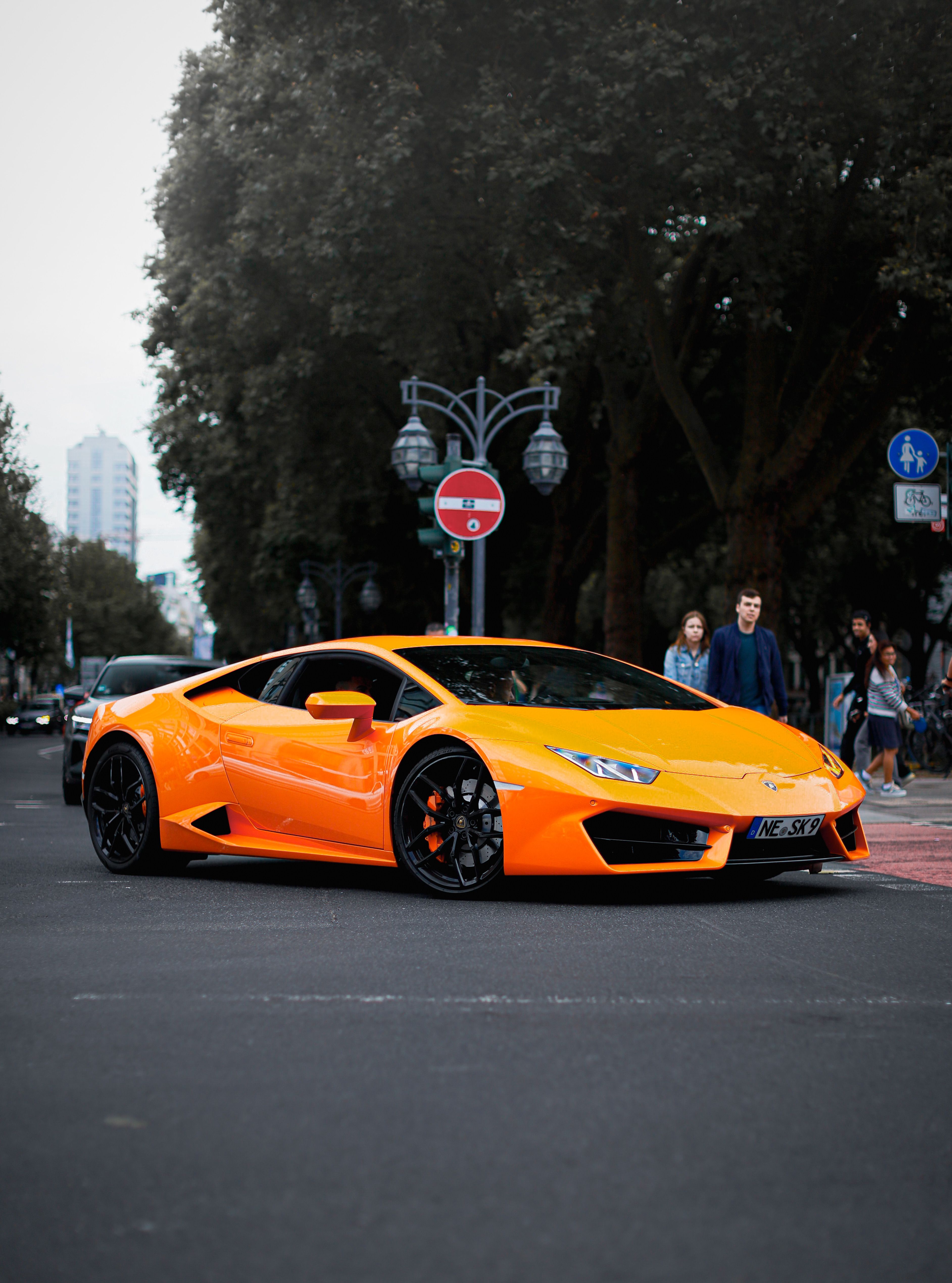 Bright Orange Supercar on City Street · Free Stock Photo