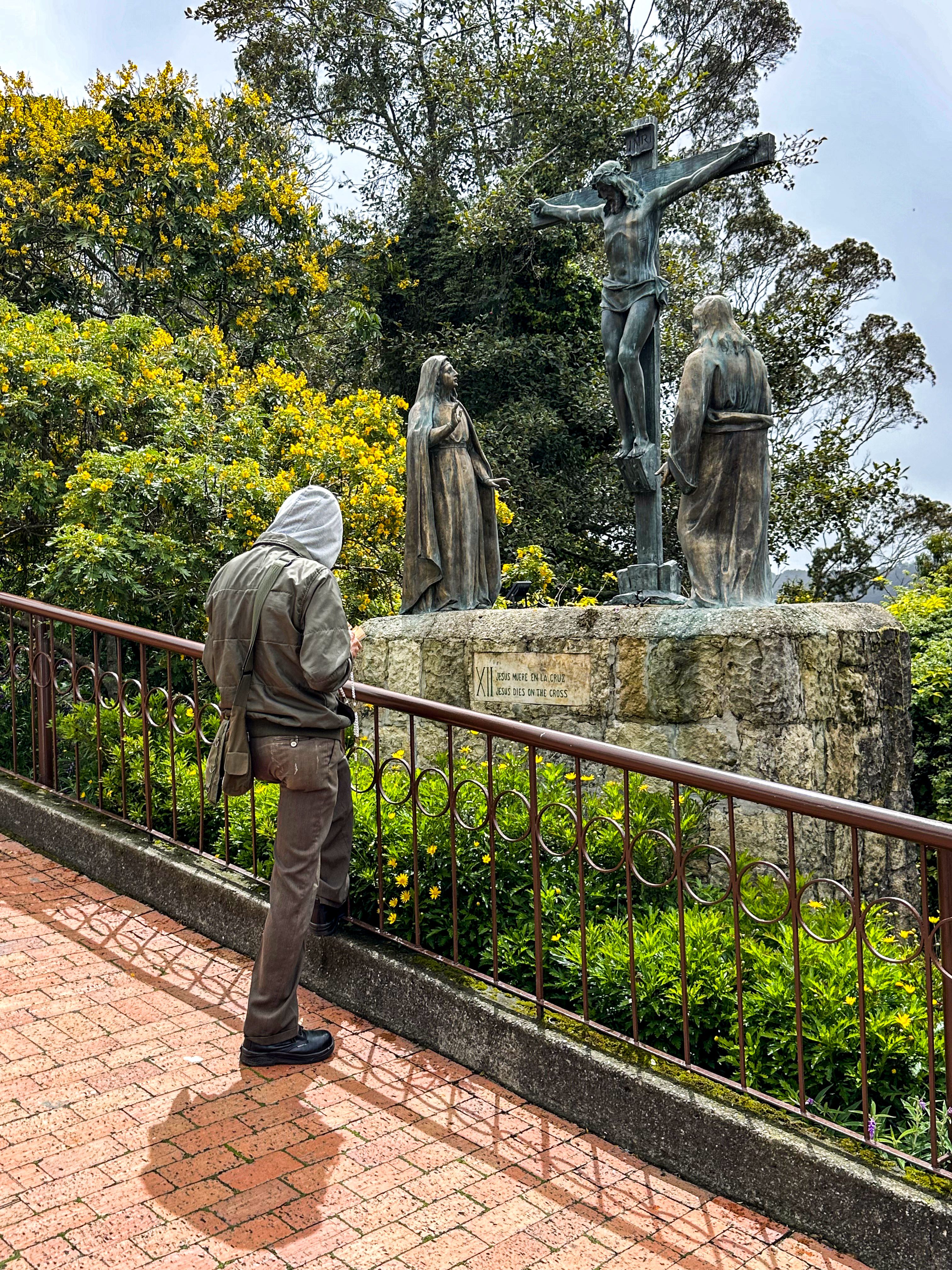 Contemplation at a Crucifixion Monument in Bogotá · Free Stock Photo