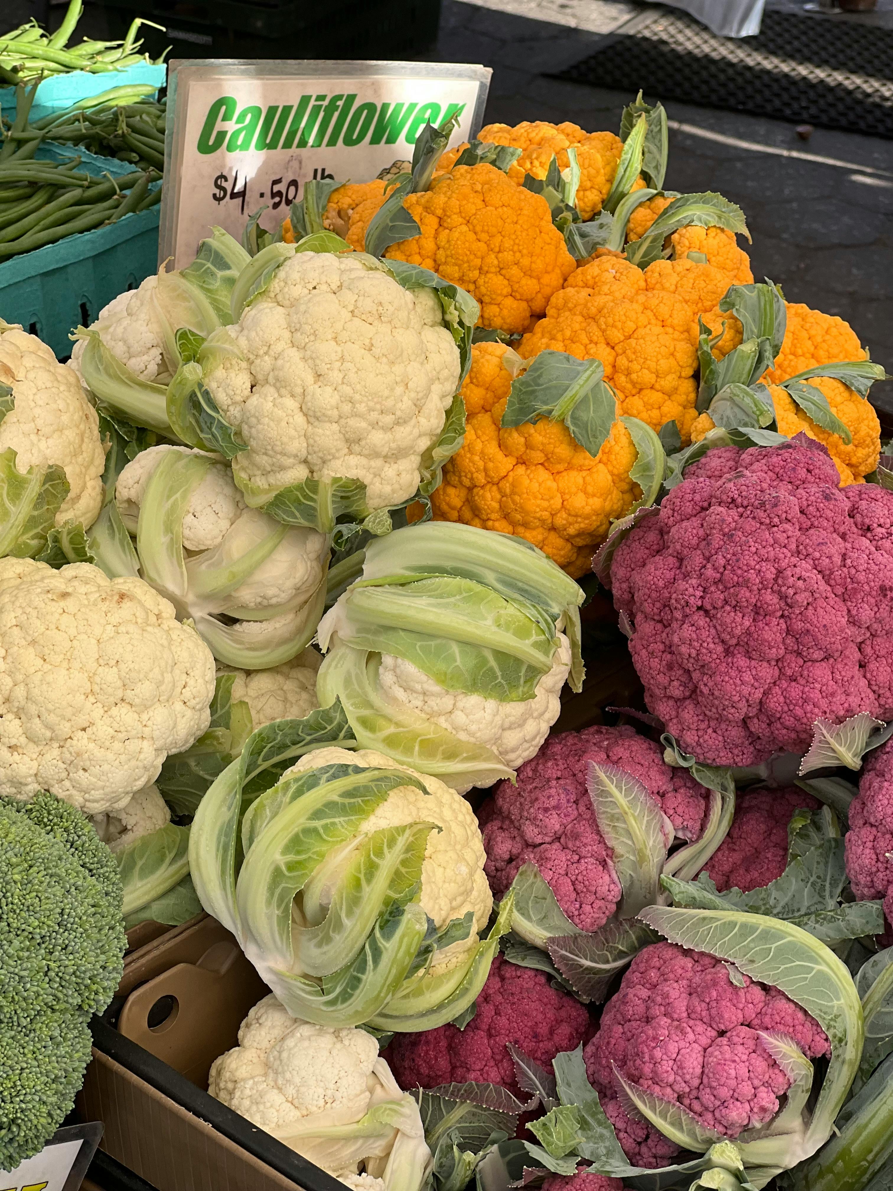 Colorful Display of Fresh Cauliflower at Market · Free Stock Photo