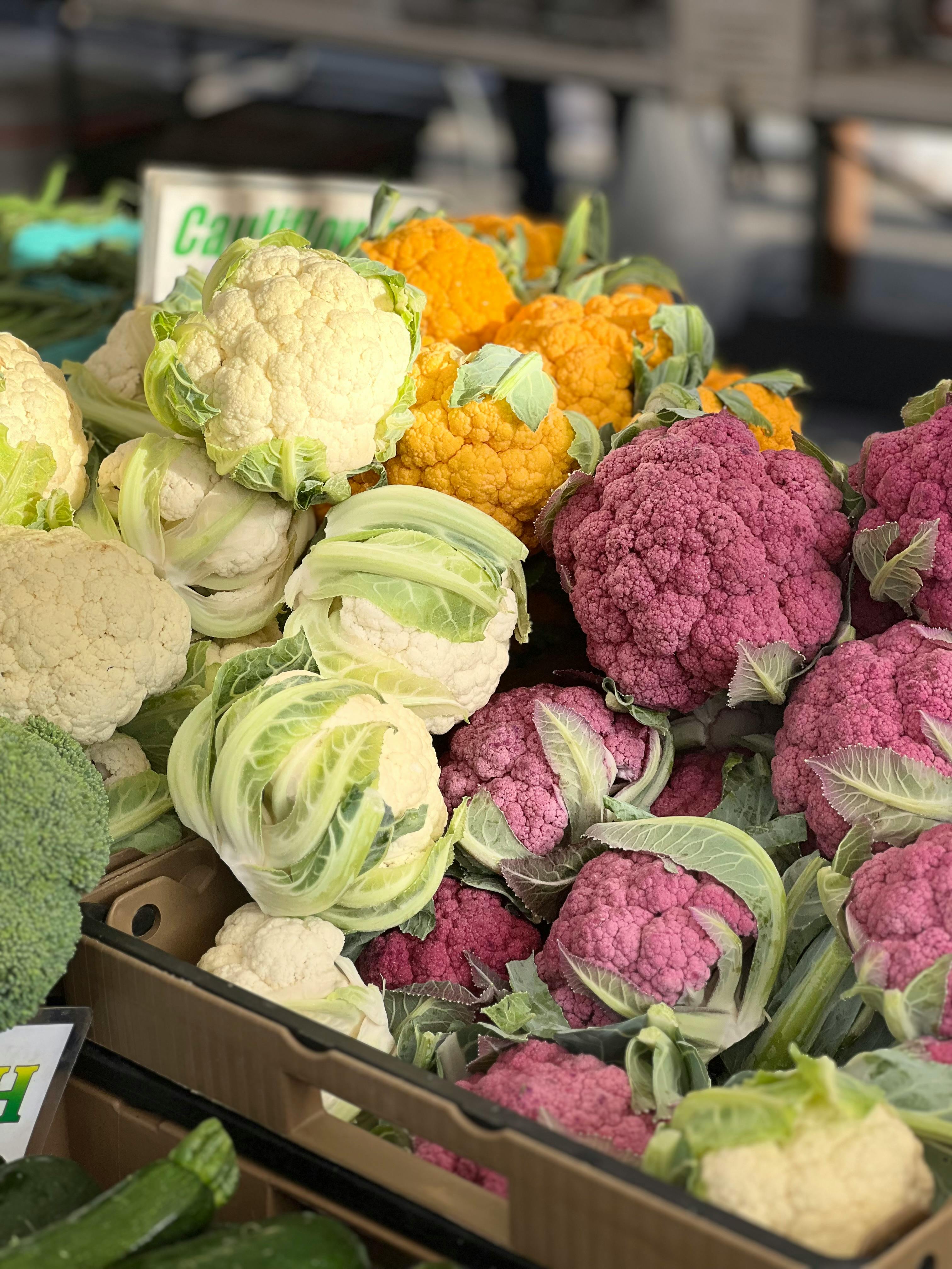 Colorful Display of Fresh Market Cauliflower · Free Stock Photo