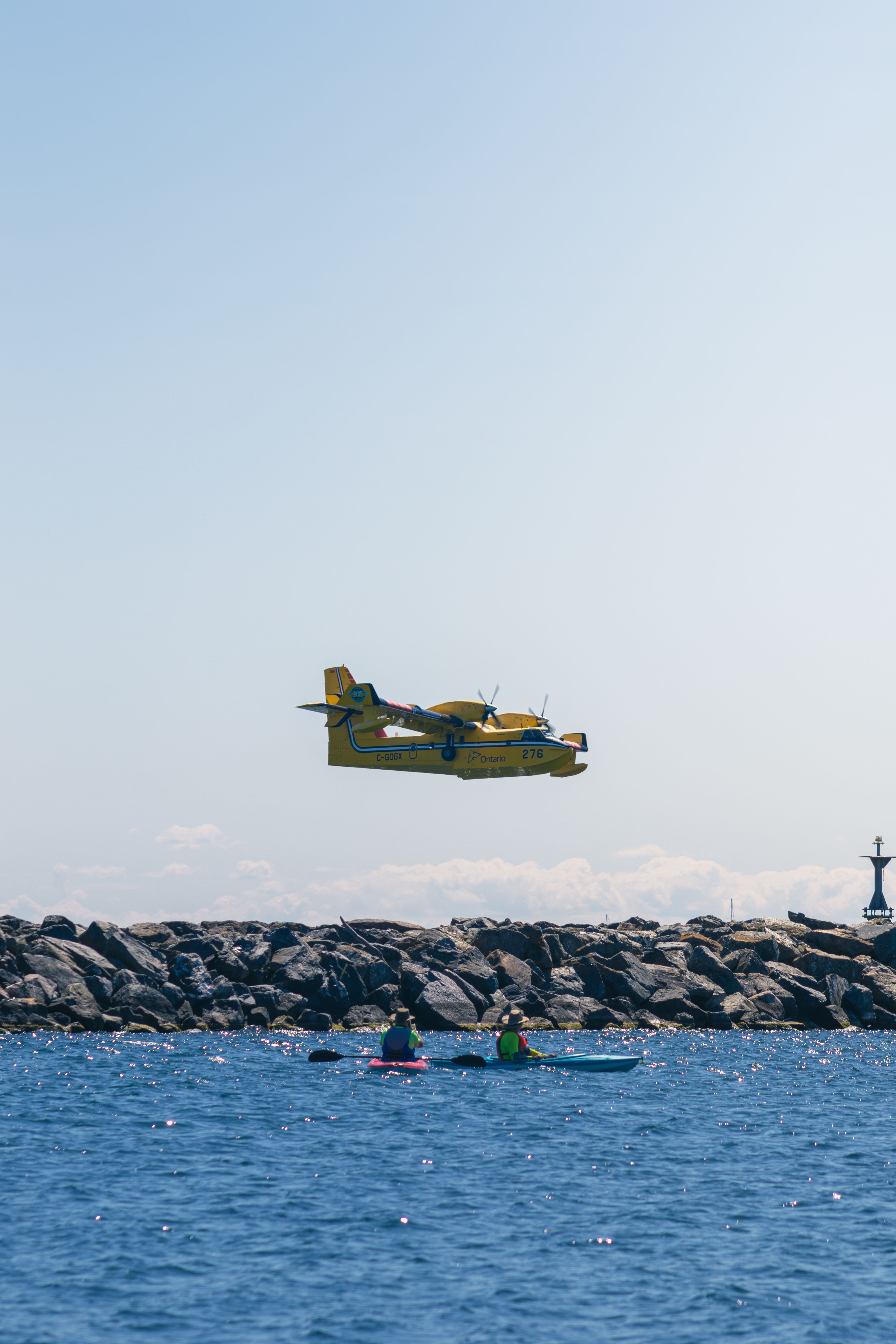 Seaplane Flying Over Kayakers in Lake Ontario · Free Stock Photo