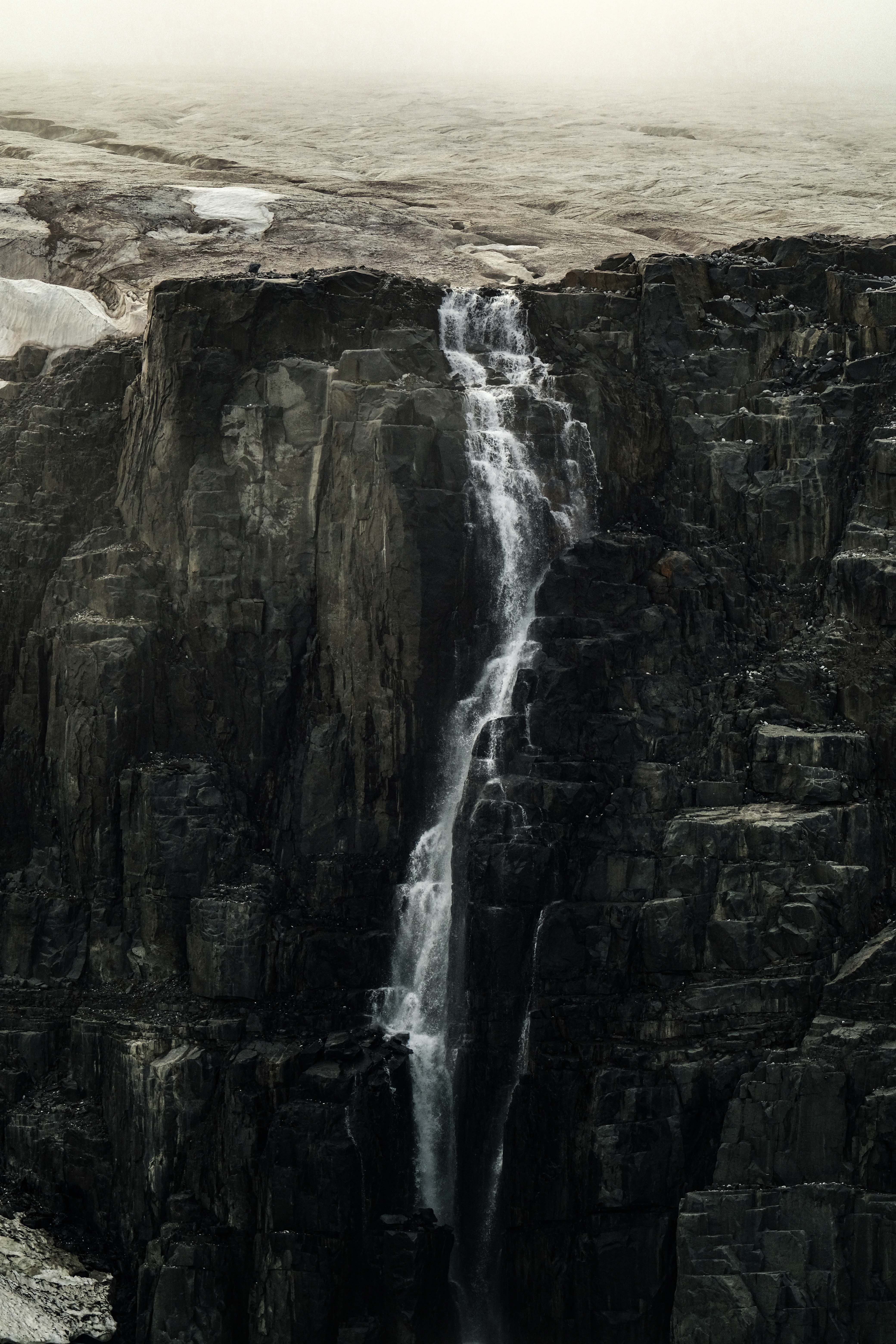 Majestic Waterfall Cascading Over Rocky Cliff · Free Stock Photo