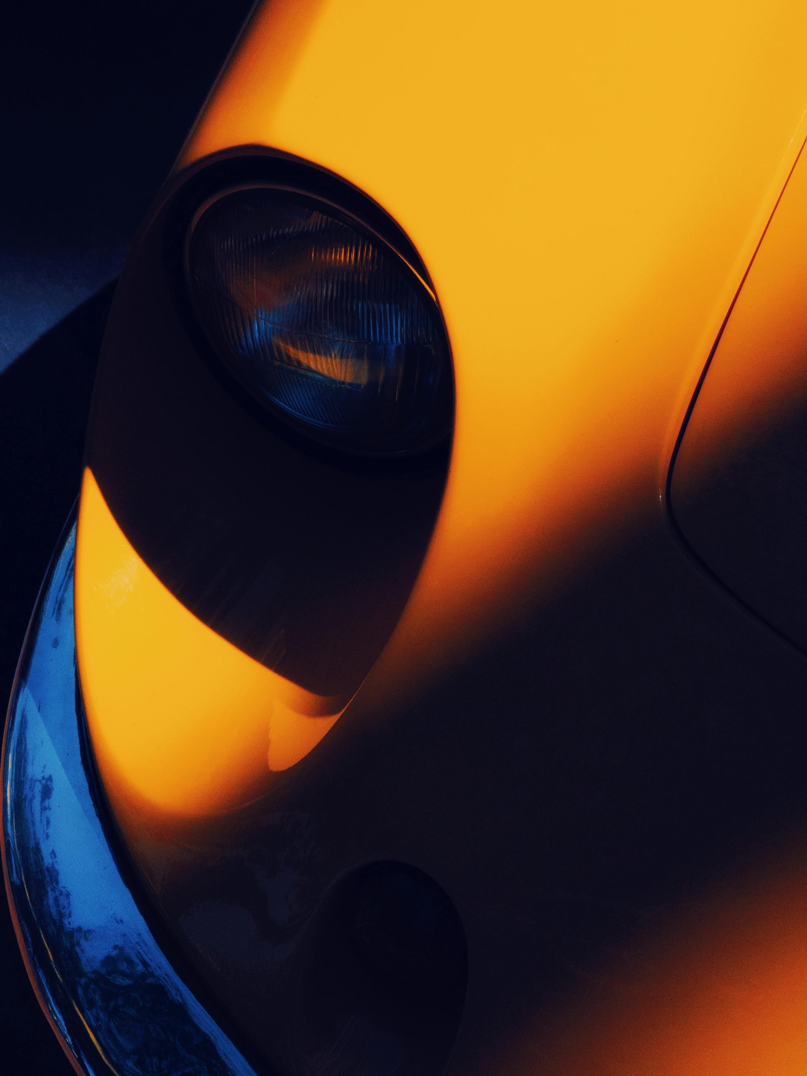 Close-up of Vintage Yellow Car Headlight in Shadow · Free Stock Photo