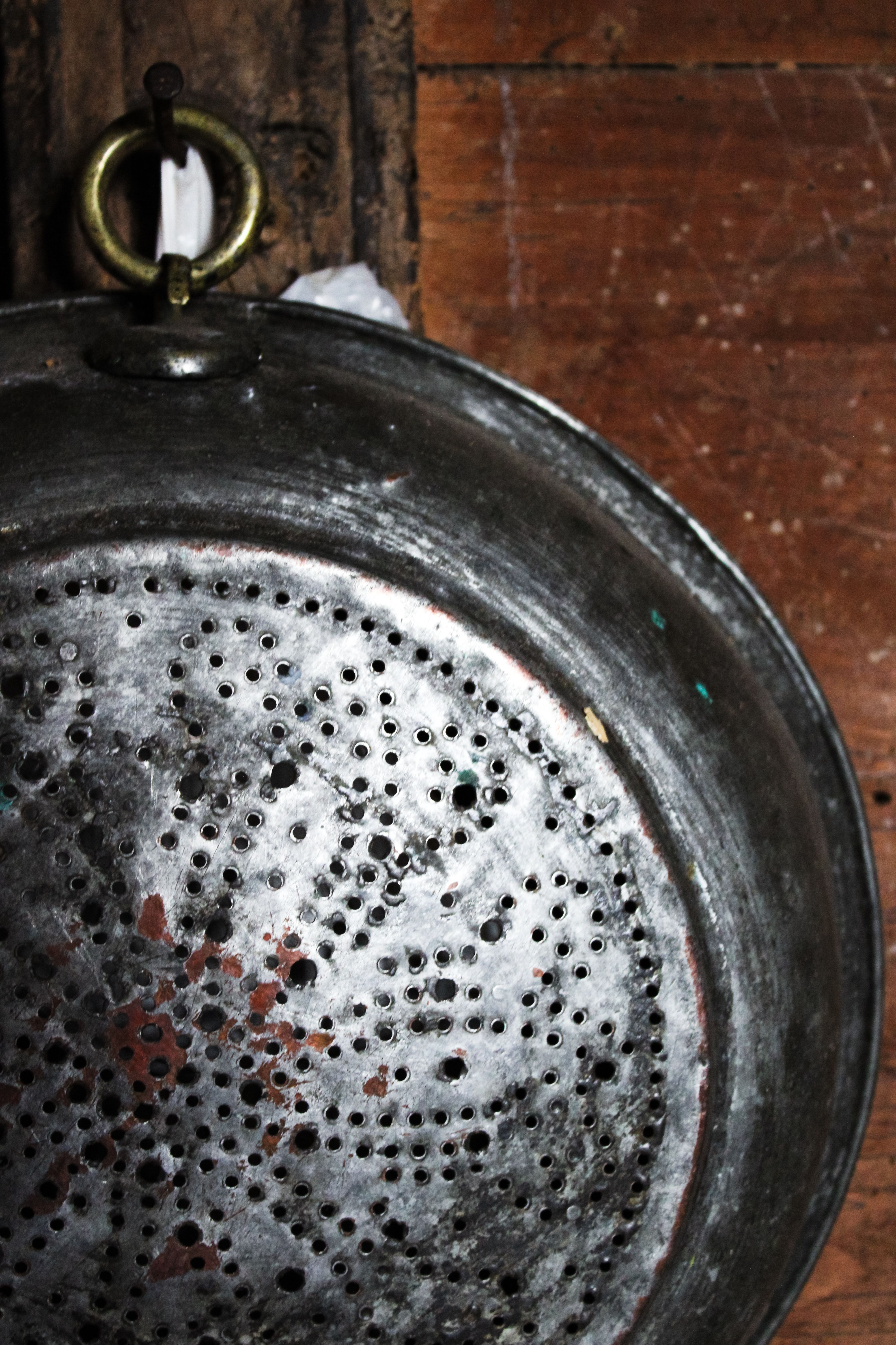 Vintage Metal Colander on Rustic Wooden Surface · Free Stock Photo