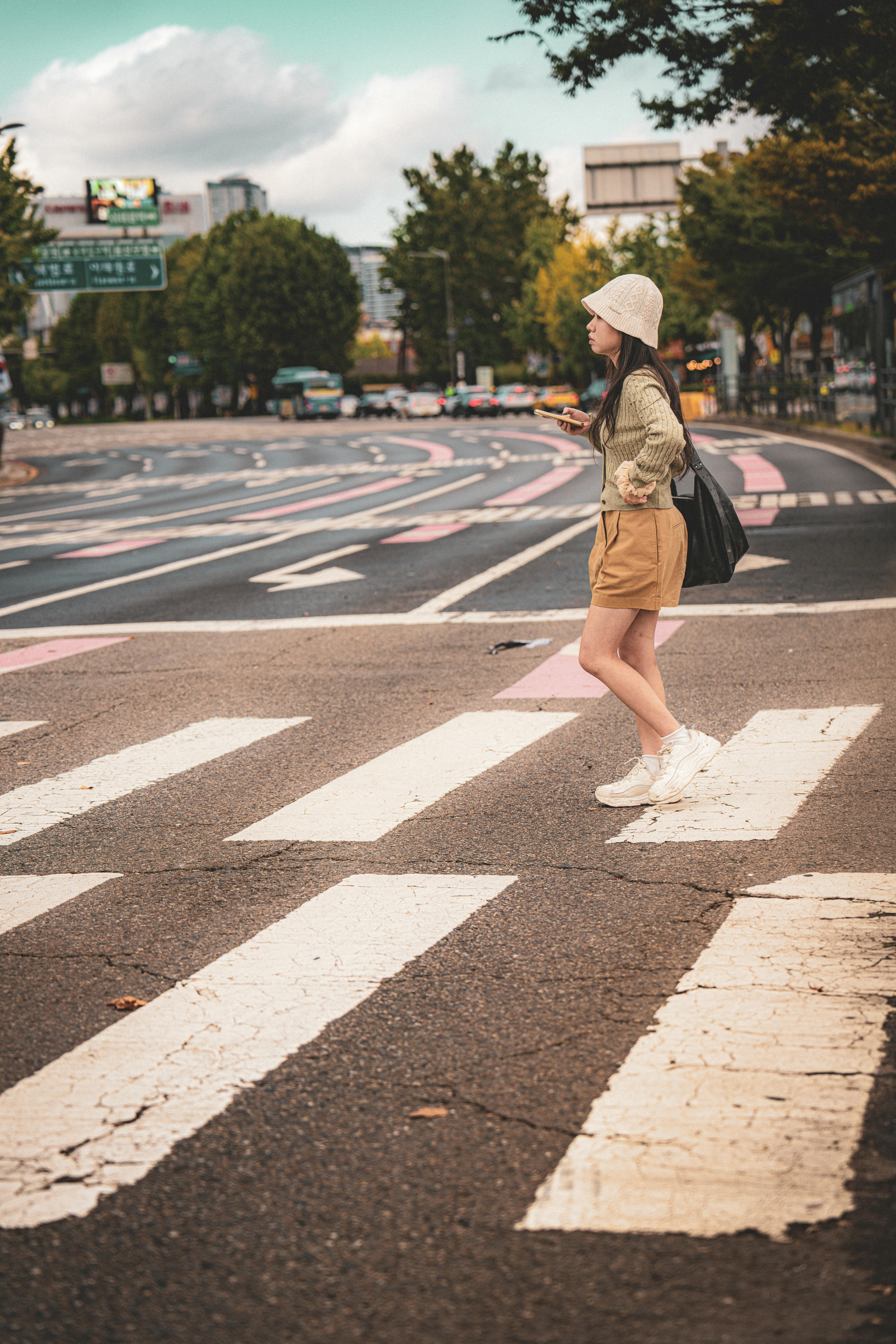 Woman Crossing a Street on Crosswalk in Urban Setting · Free Stock Photo