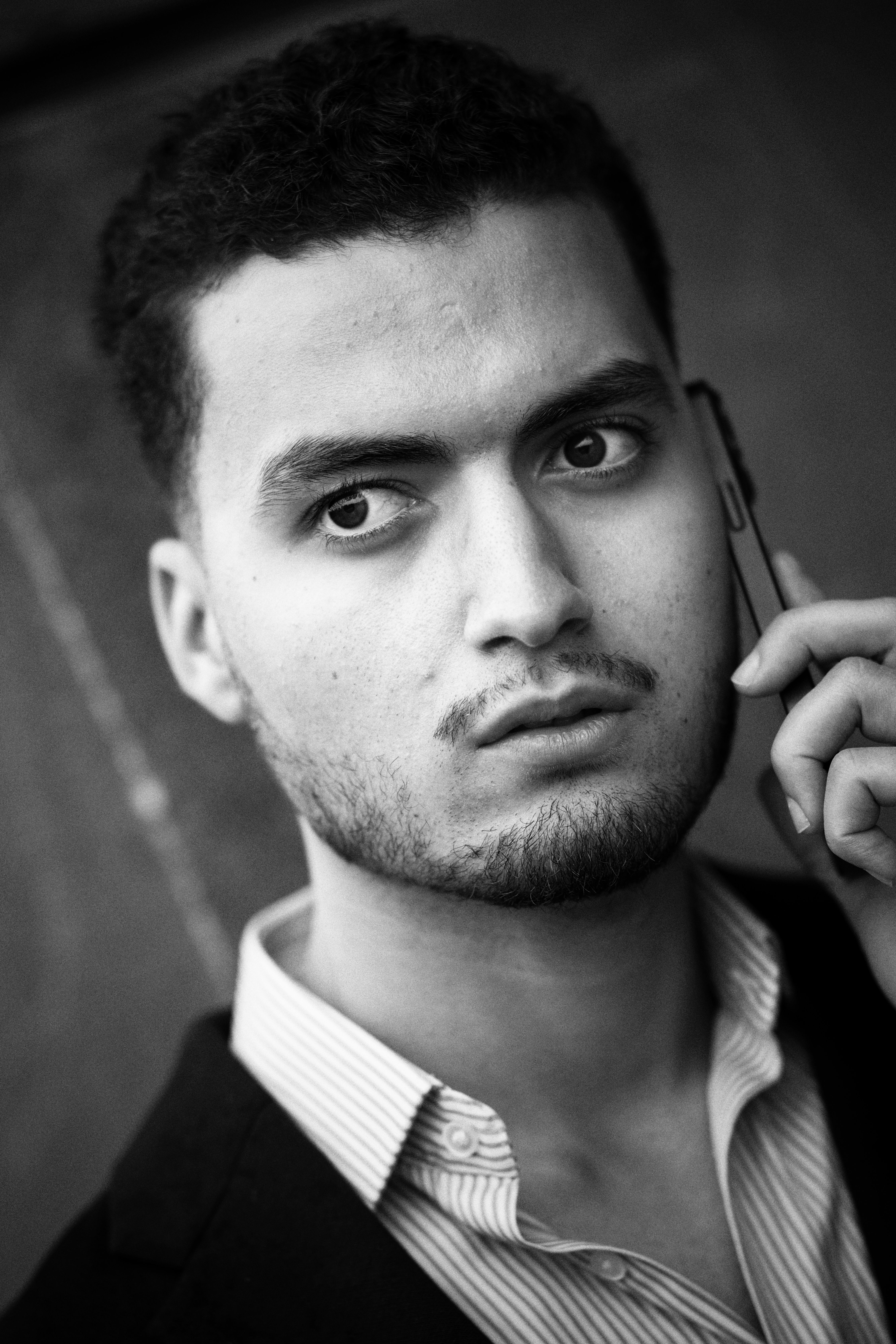 Dynamic Black and White Portrait of Young Man on Phone · Free Stock Photo