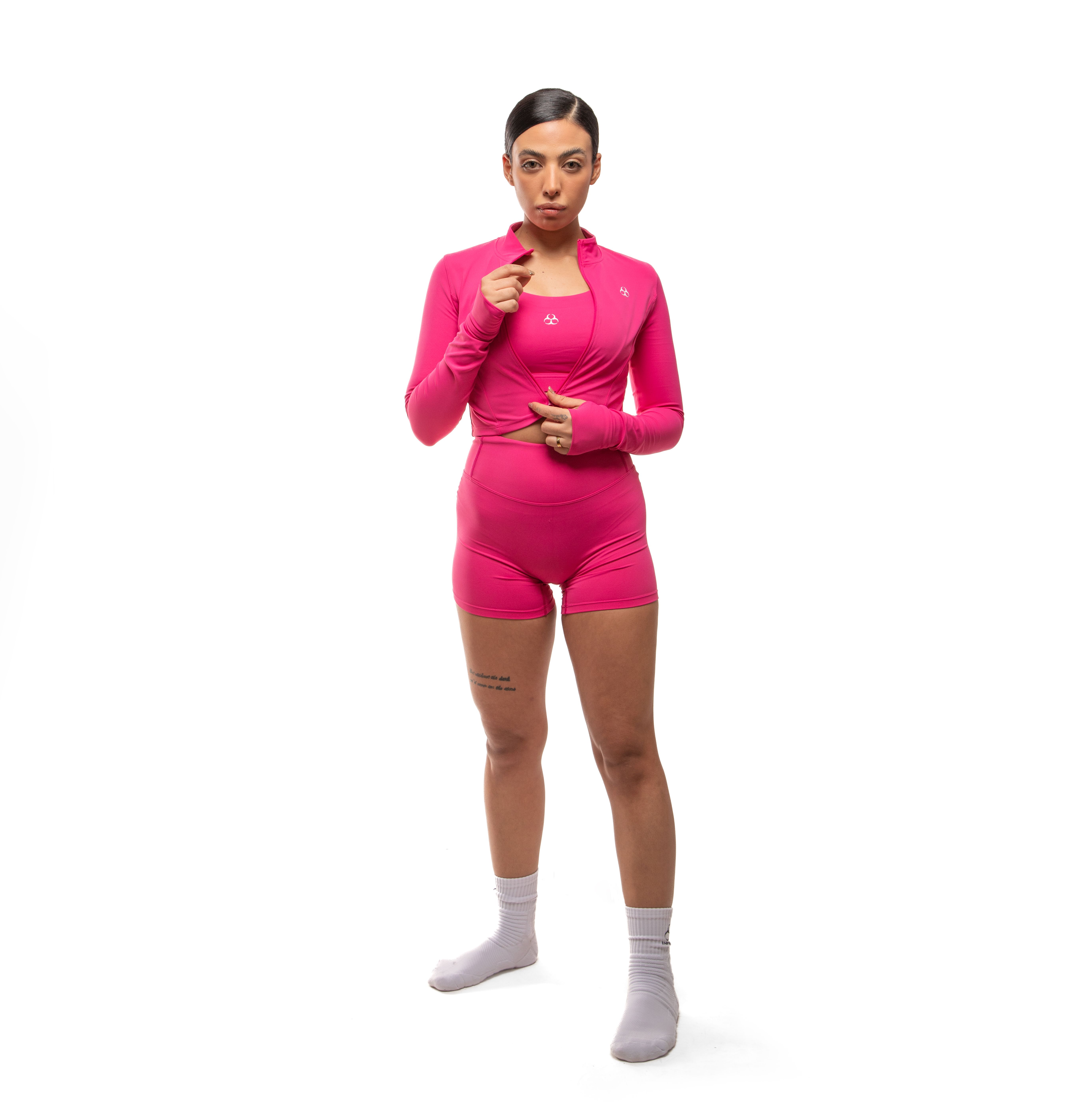 Woman in Pink Activewear Posing on White Background · Free Stock Photo