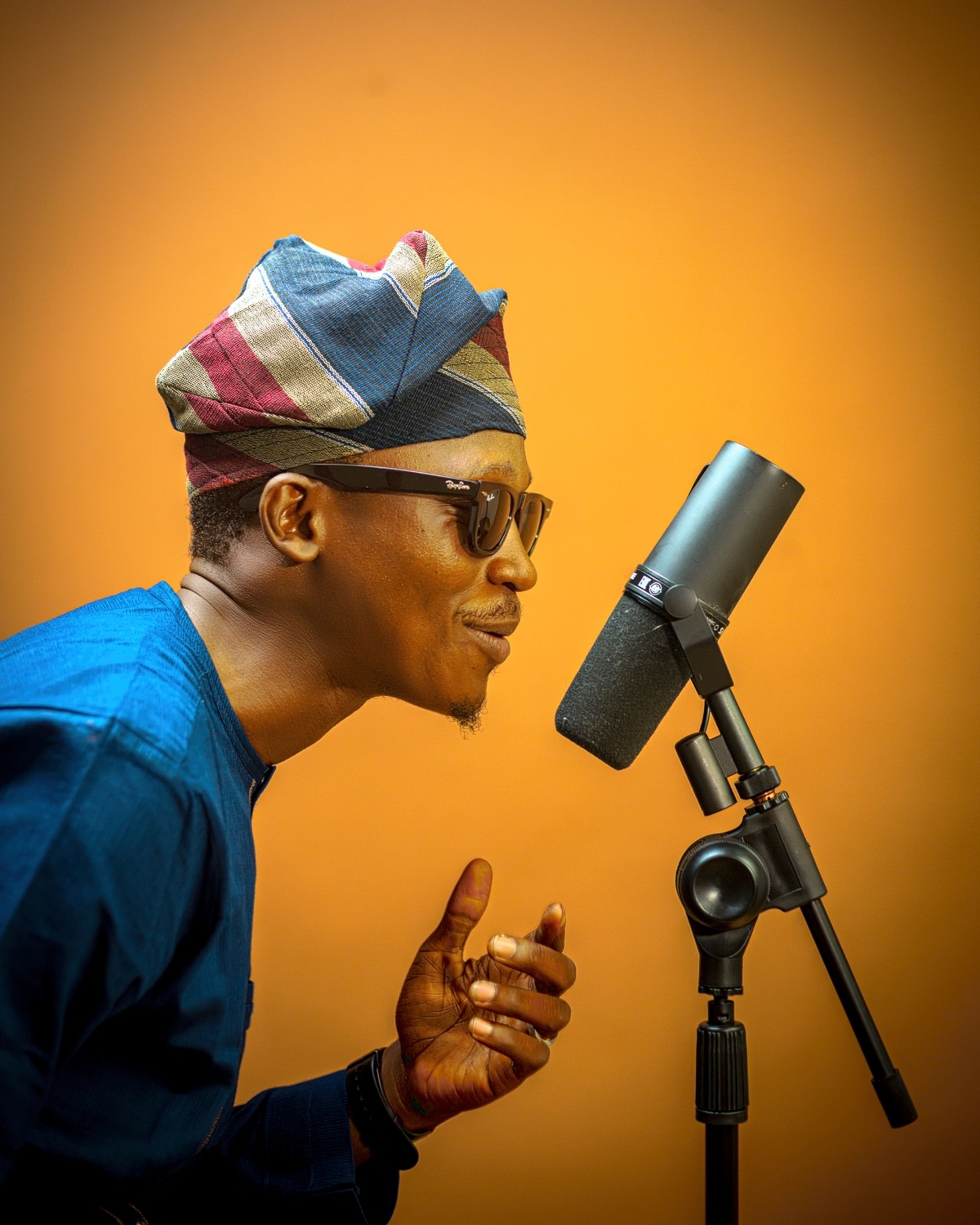 African man singing in traditional attire with microphone · Free Stock ...