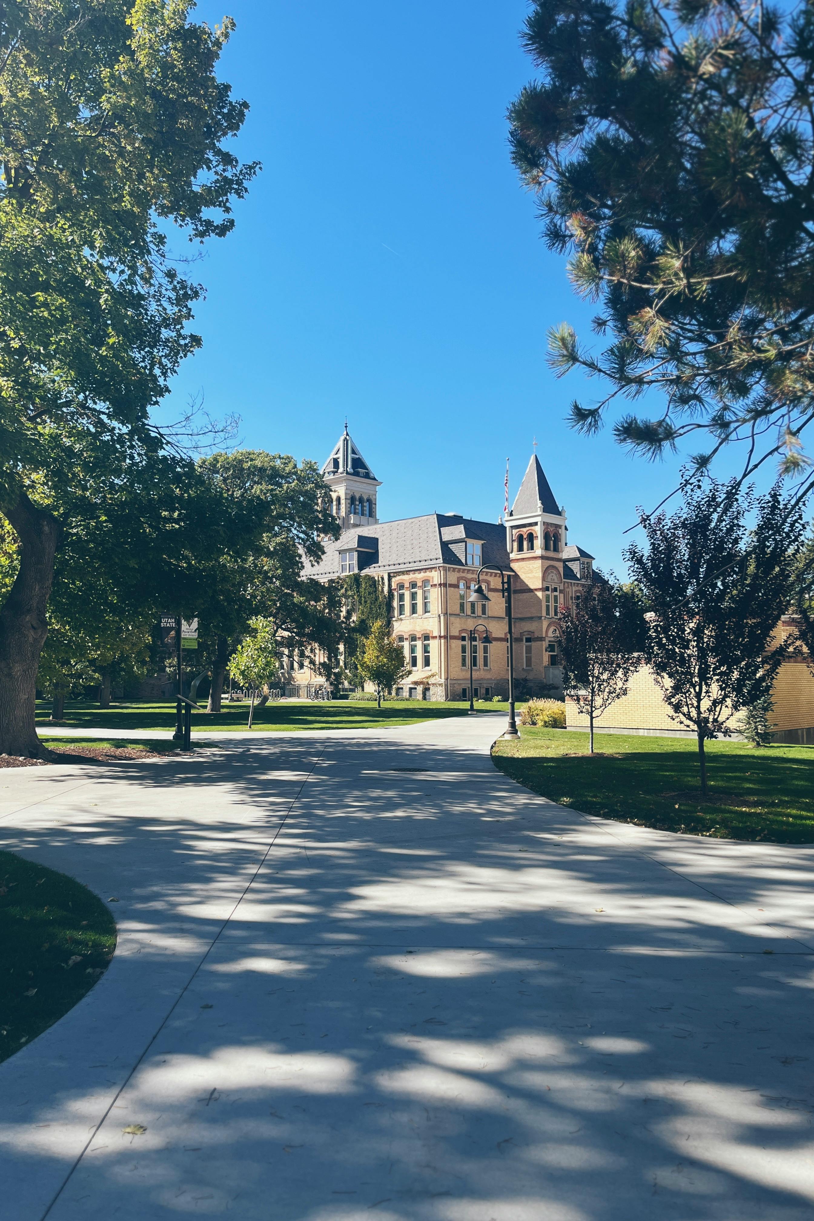 Free A historic university building surrounded by trees under clear ...