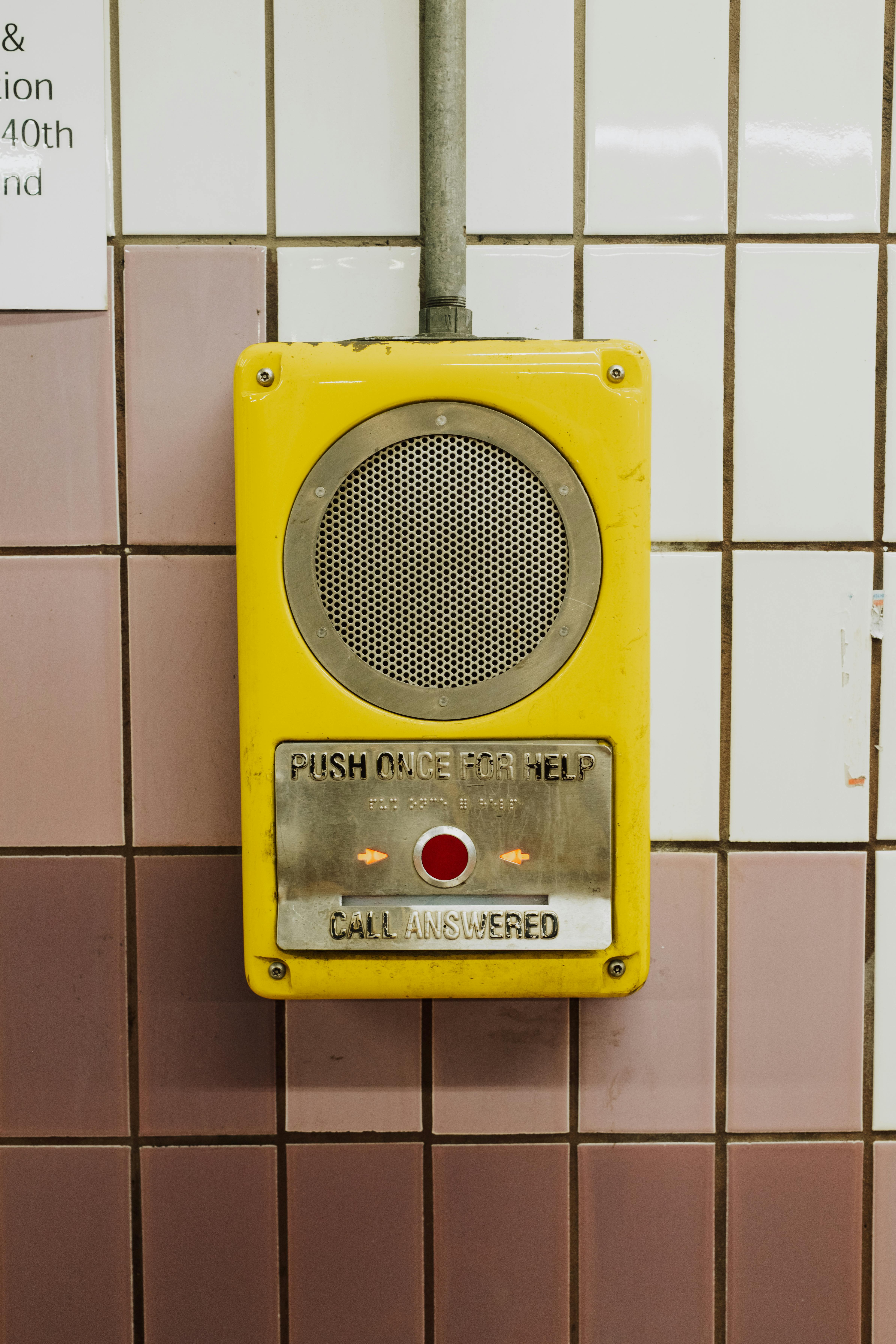 Yellow Emergency Call Button on Subway Wall · Free Stock Photo