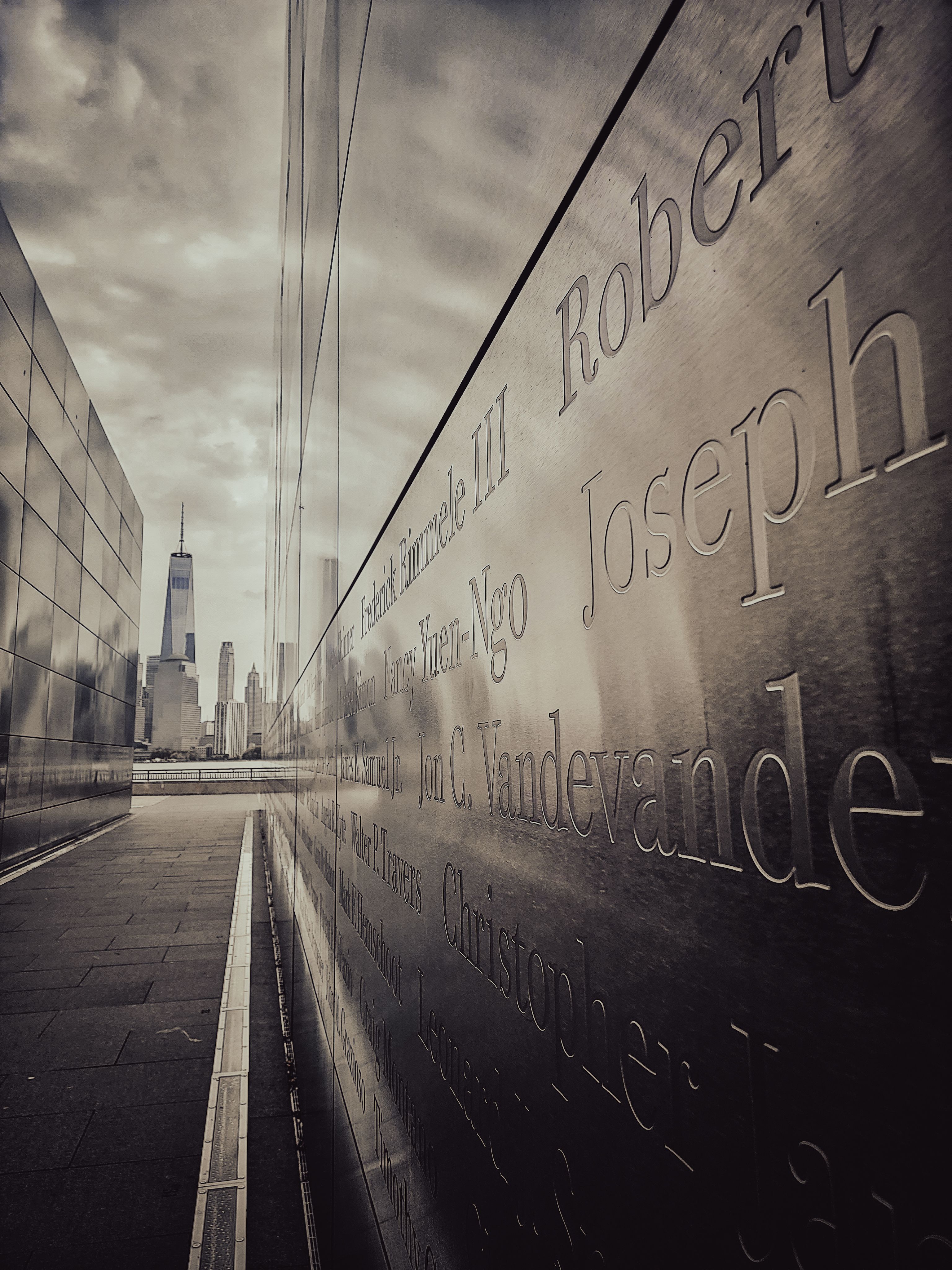 Reflective Memorial with City Skyline in Background · Free Stock Photo
