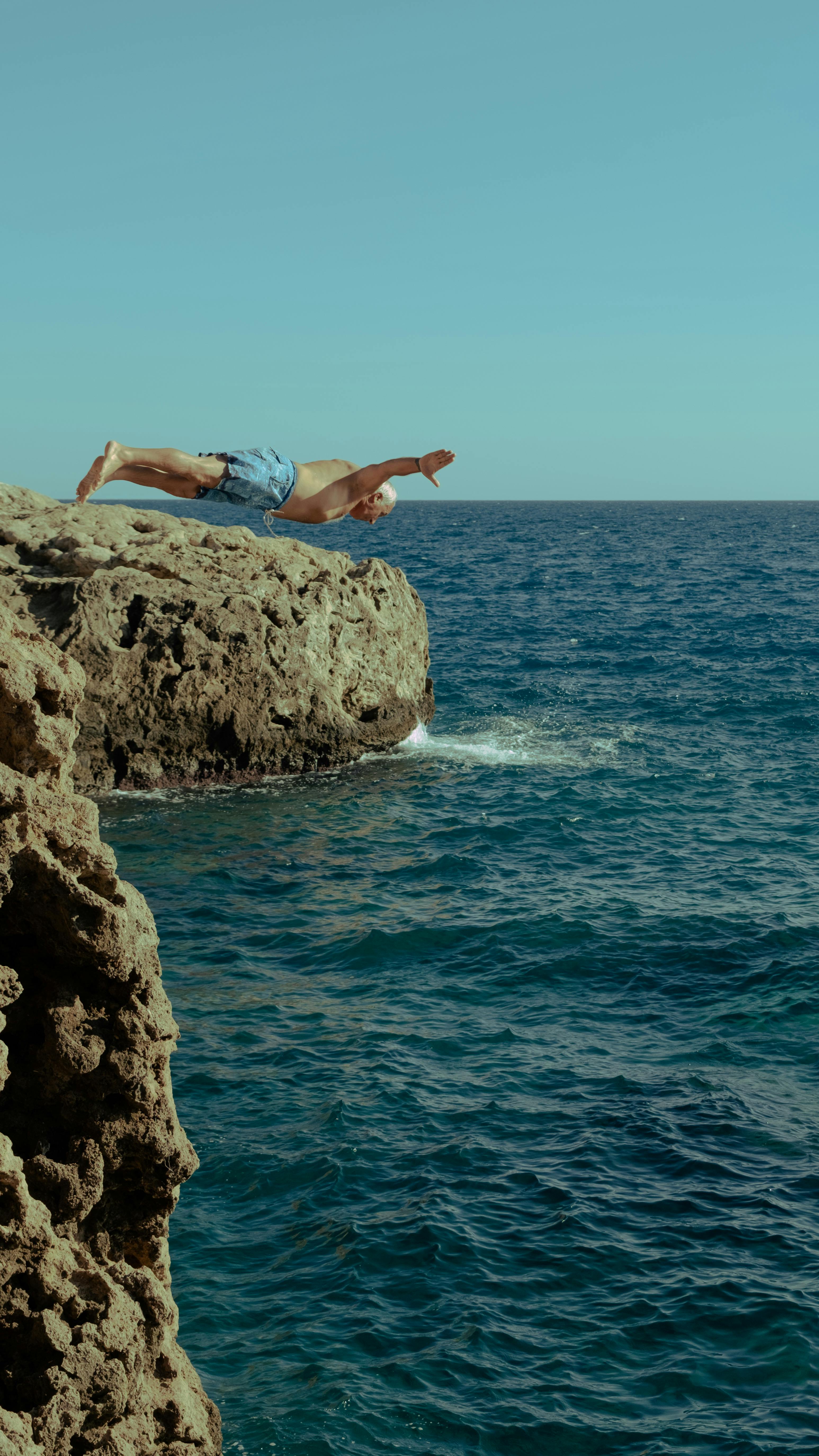 Man Diving into the Mediterranean Sea from Cliffs · Free Stock Photo