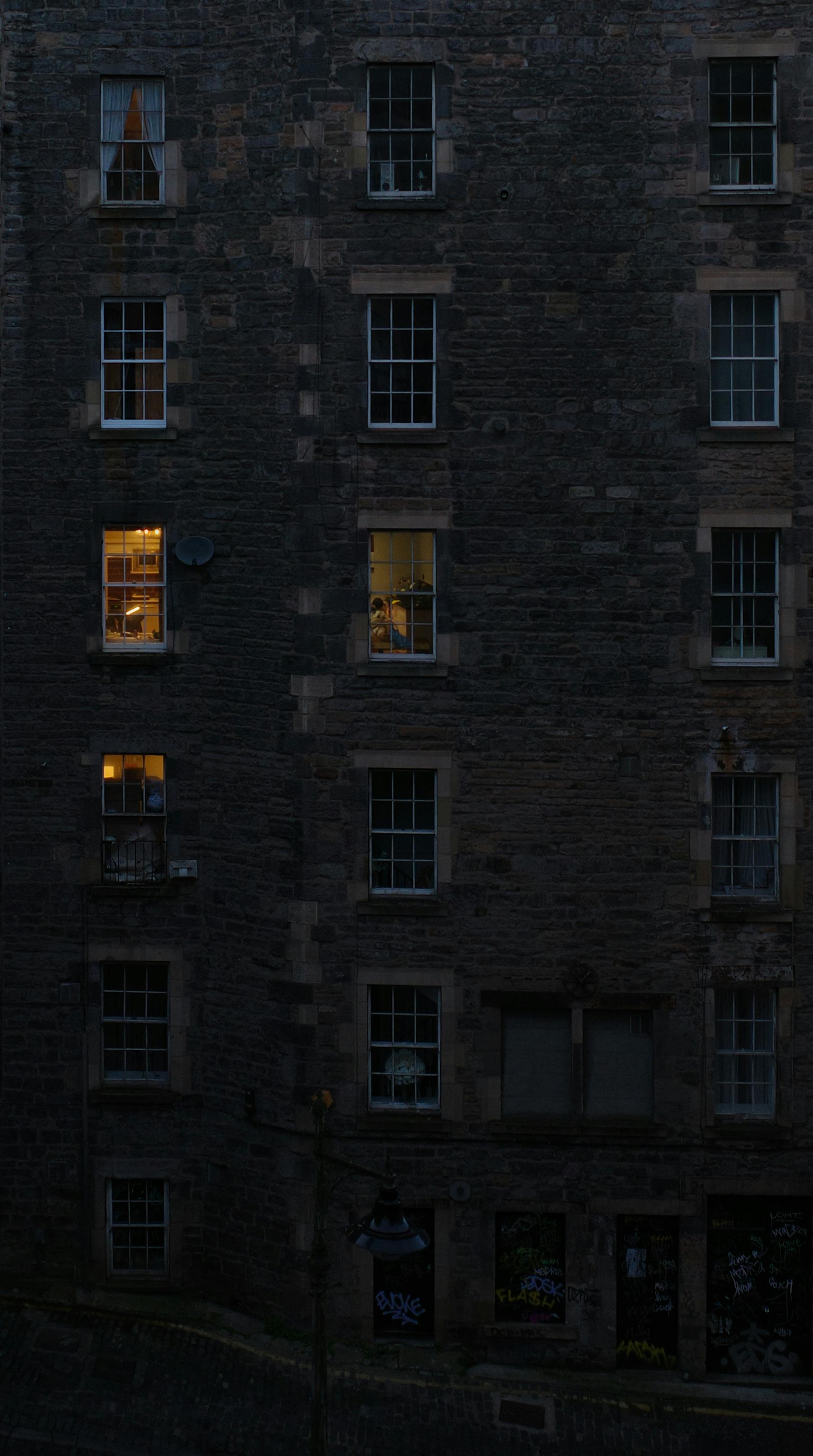 Cozy Apartment Windows at Night in Urban Setting · Free Stock Photo