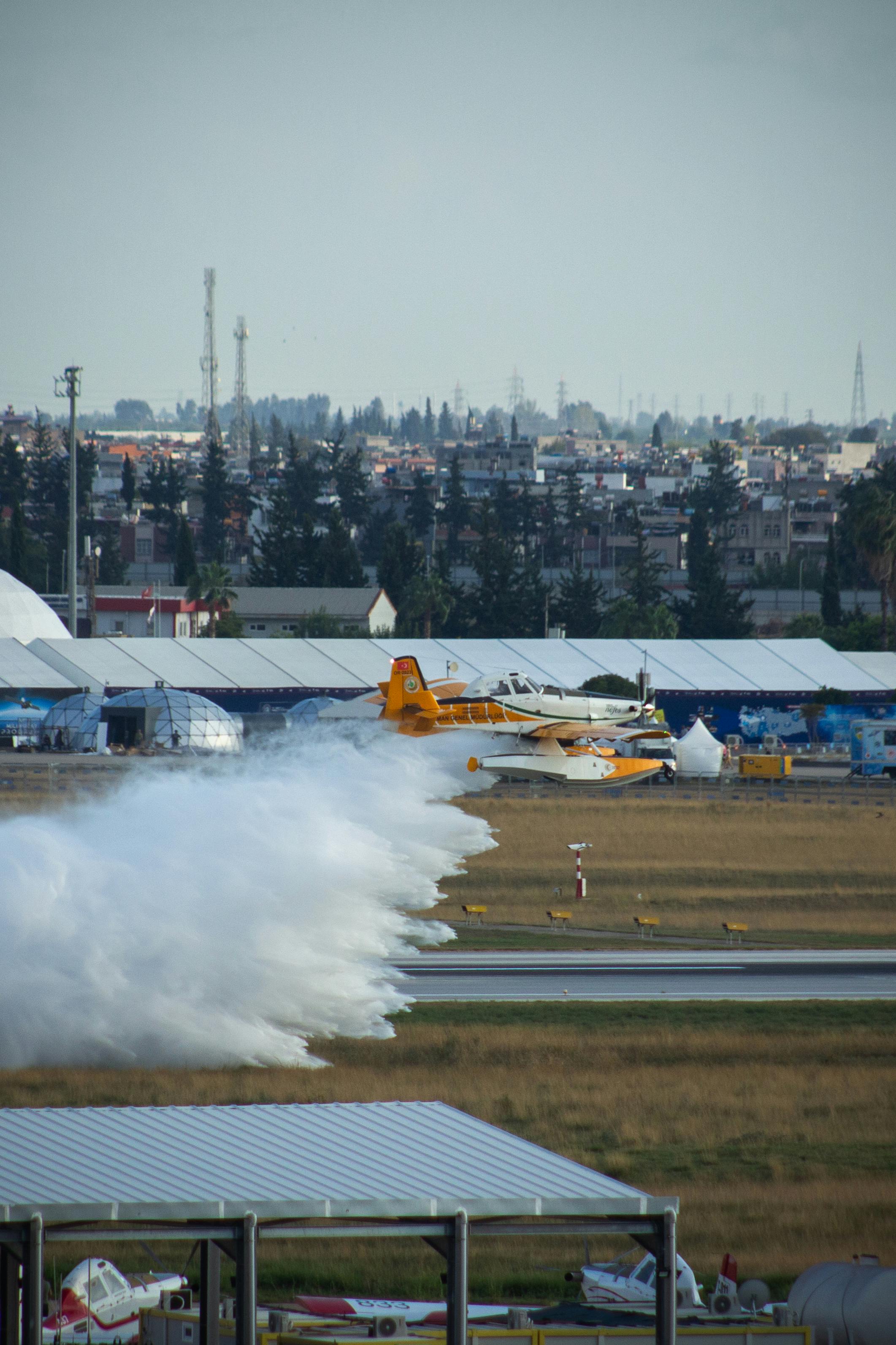 Firefighting Aircraft Performing Water Drop at Airfield · Free Stock Photo