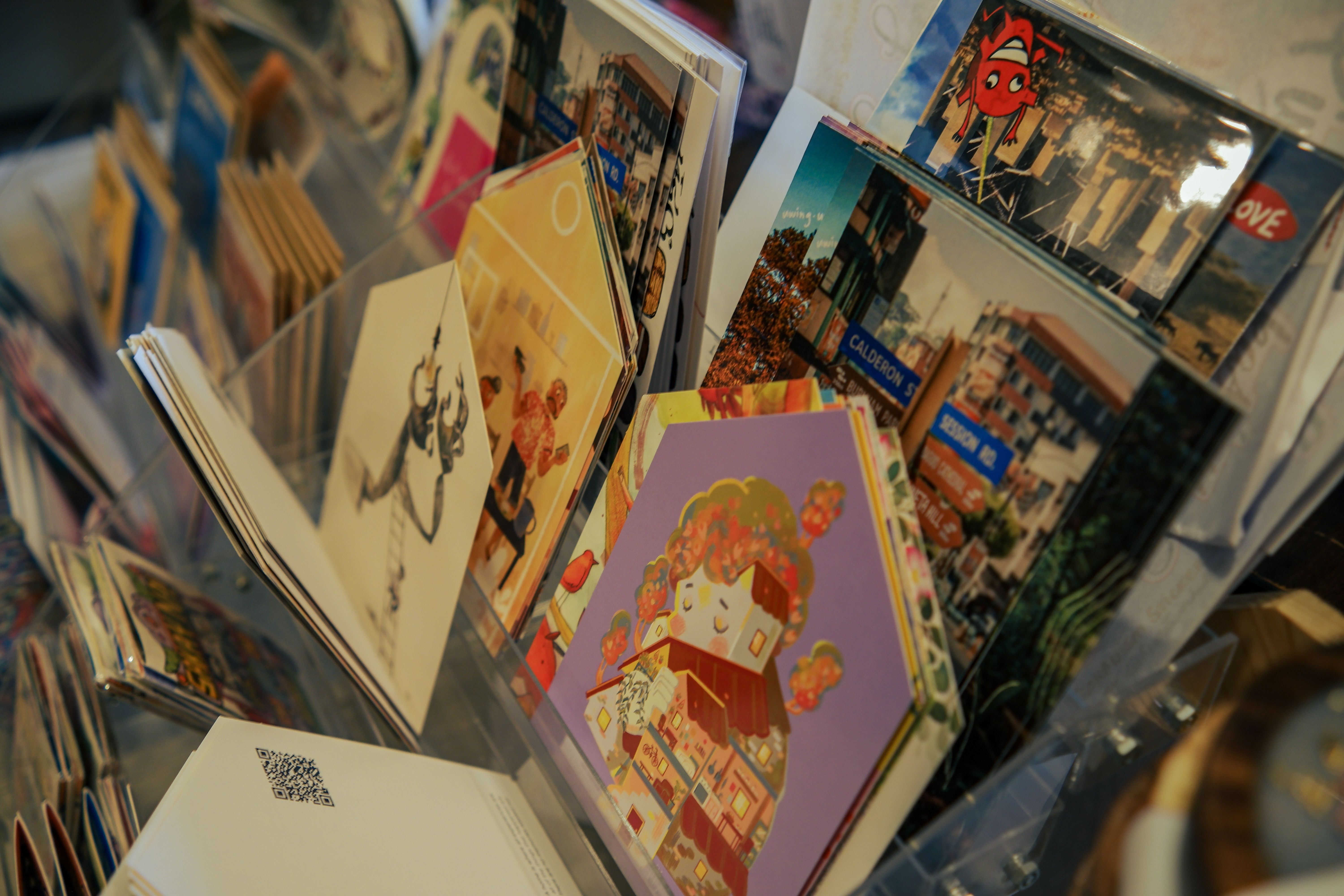 Collection of Artistic and Scenic Postcards Displayed · Free Stock Photo