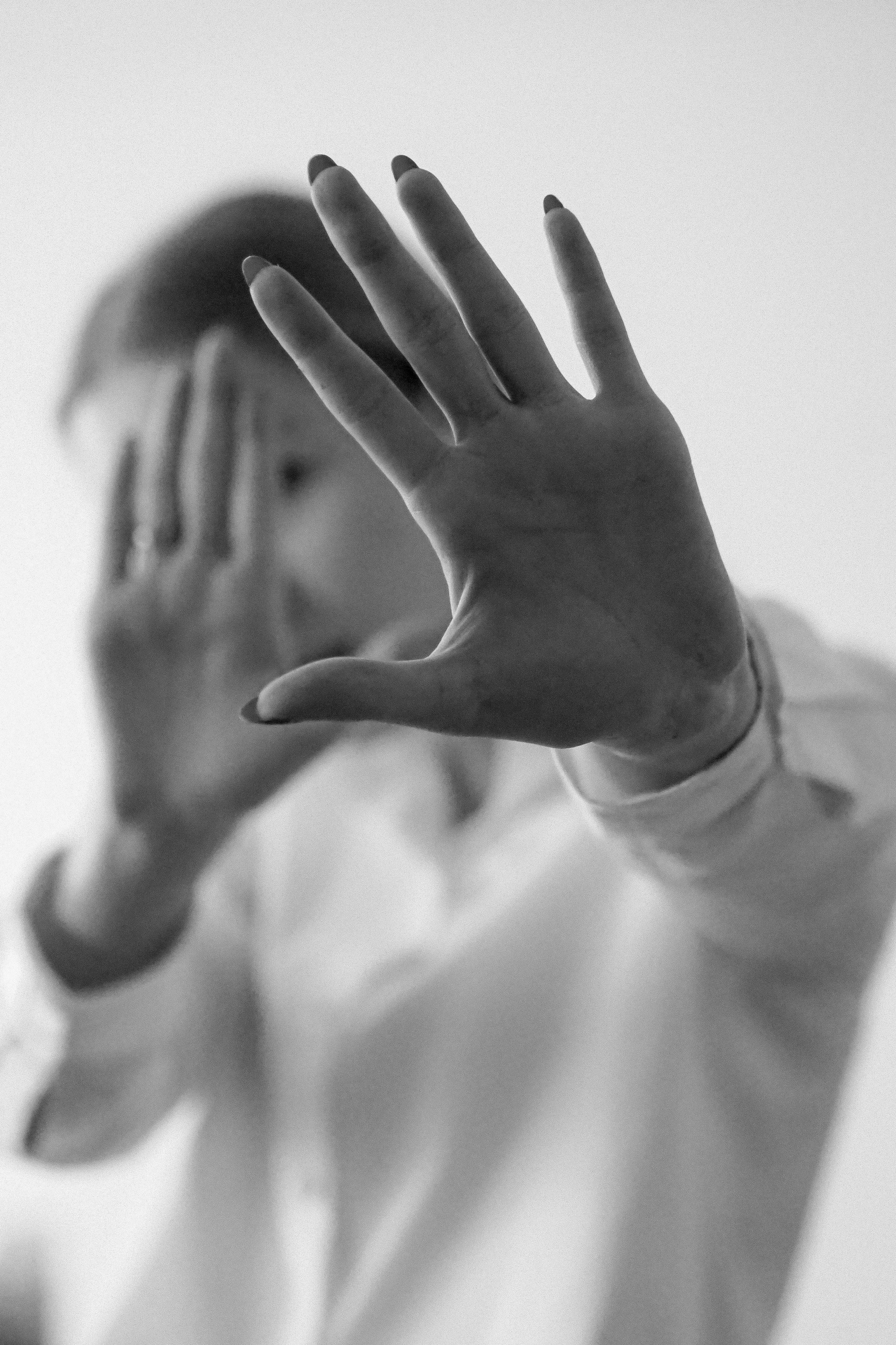 Monochrome Hands Blocking Camera Close-up · Free Stock Photo